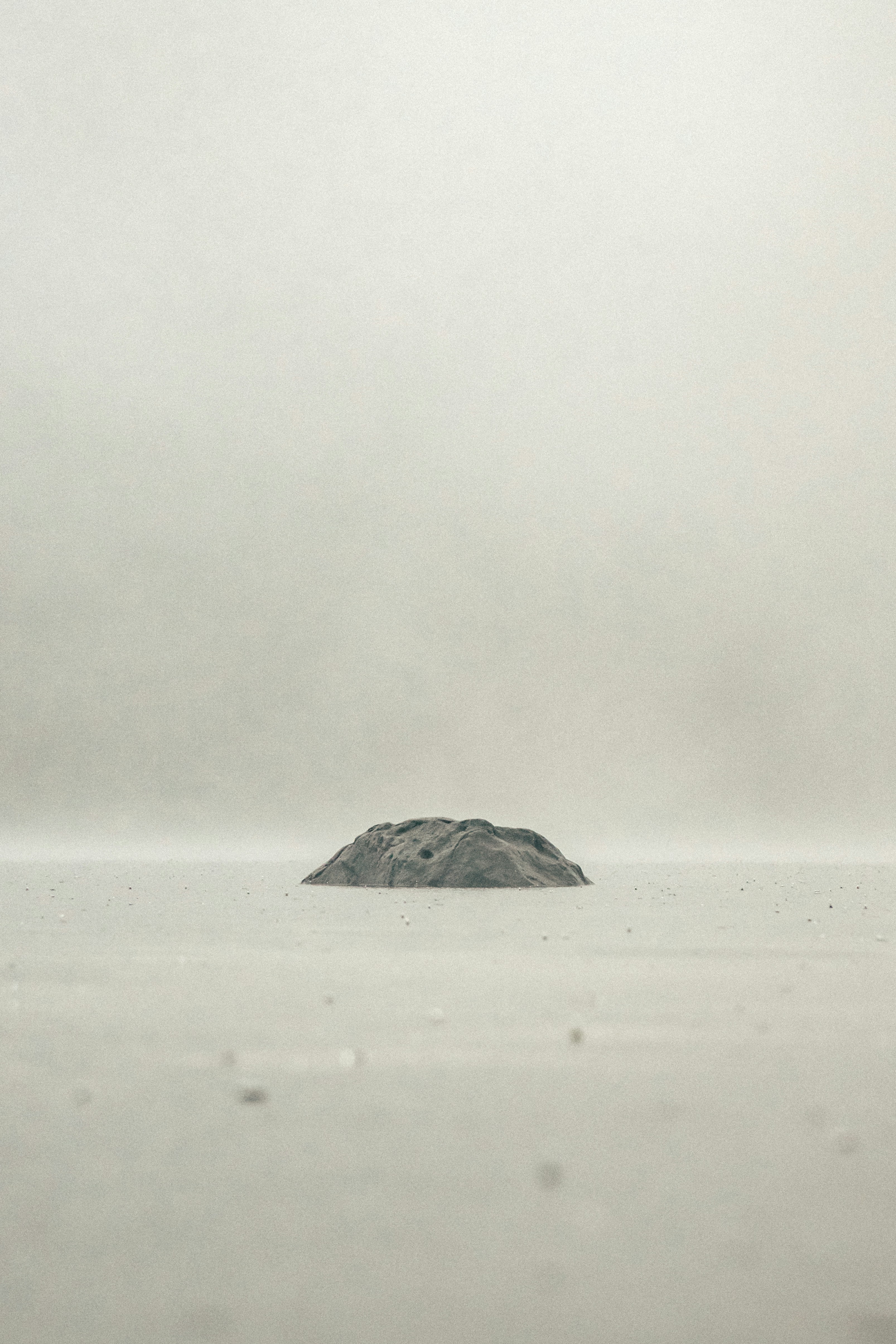 Solitary Rock in a Mist-Washed Plain
