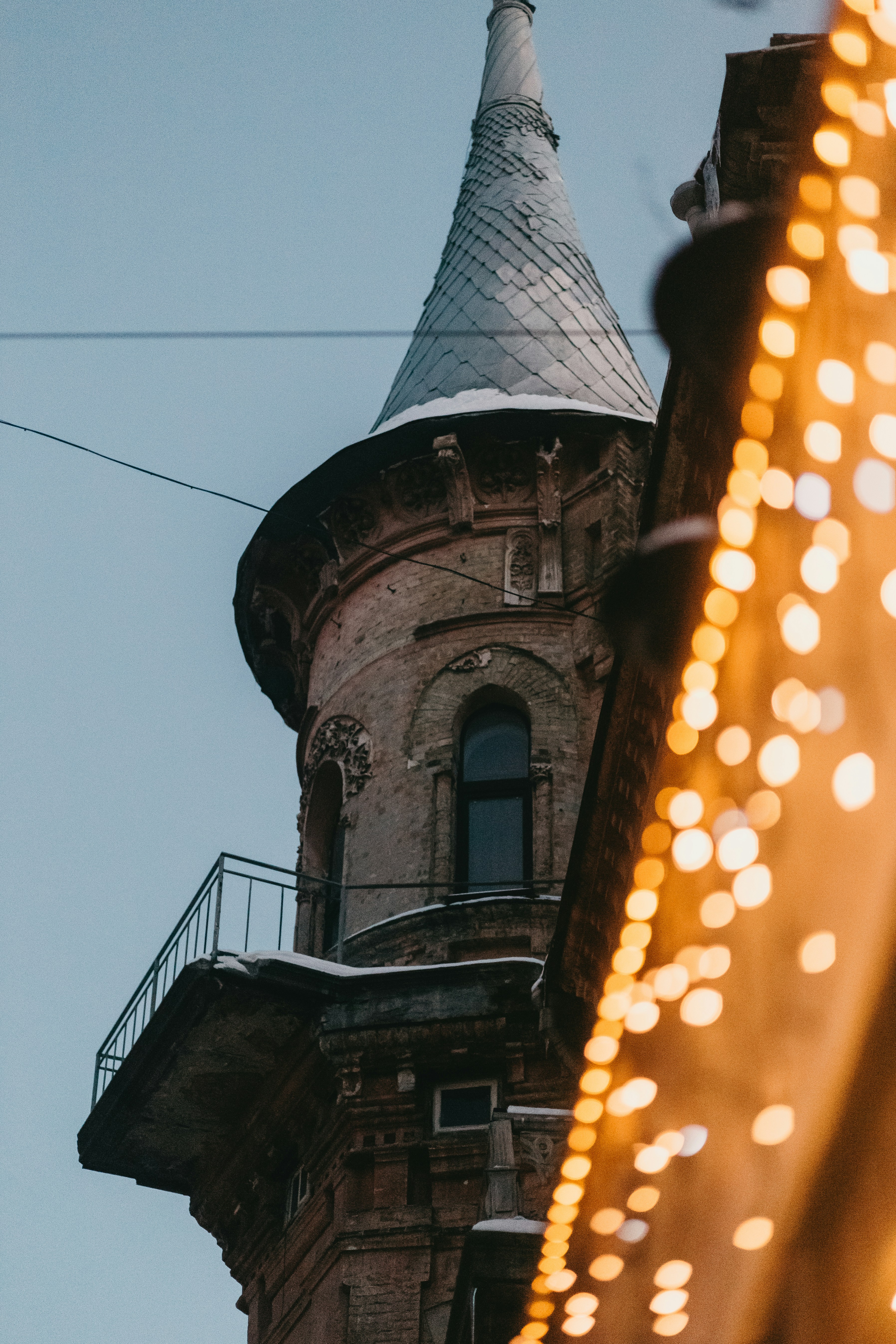 Turreted Tower in Twilight, Framed by Golden Orbs