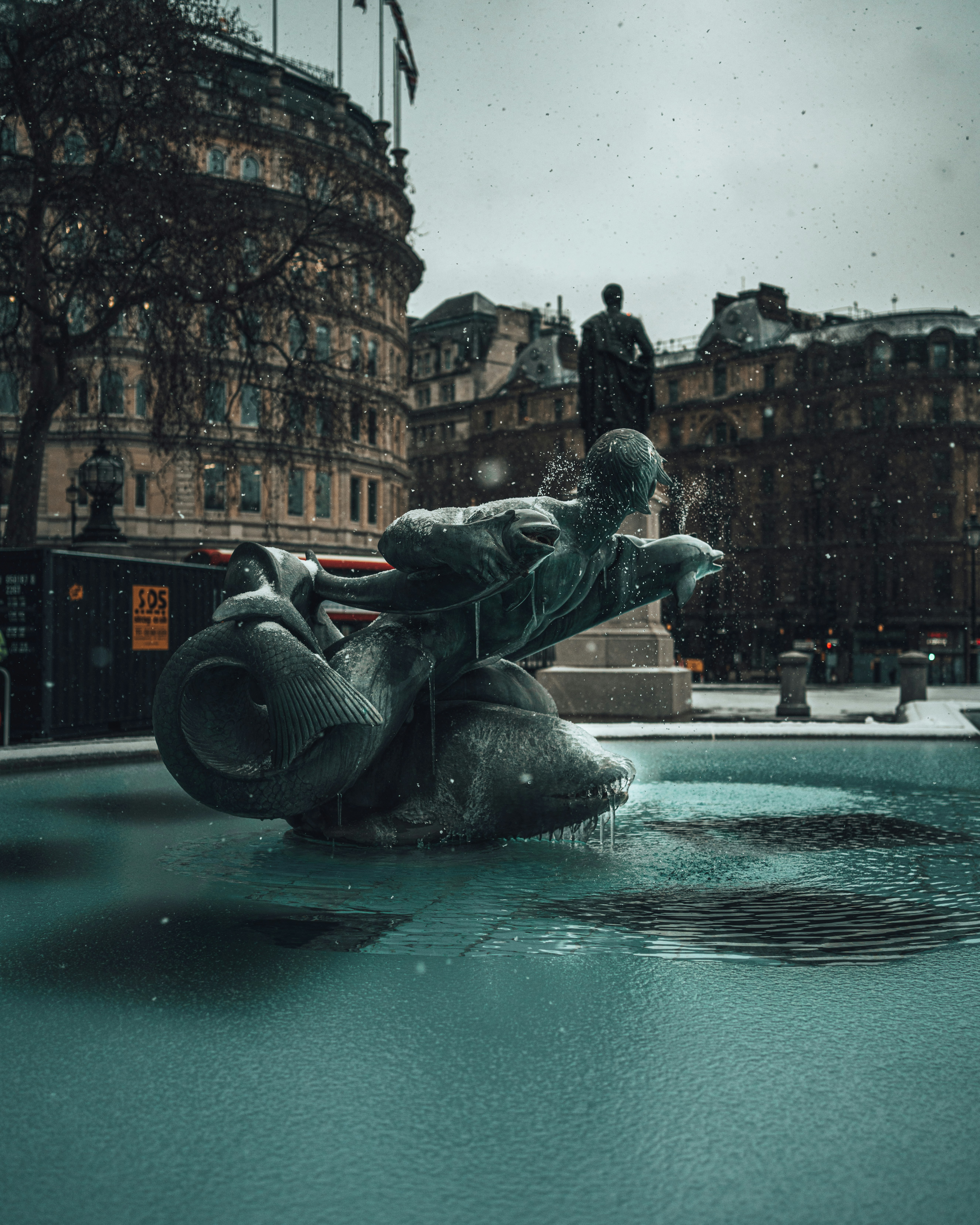 man riding on horse statue in the middle of the city