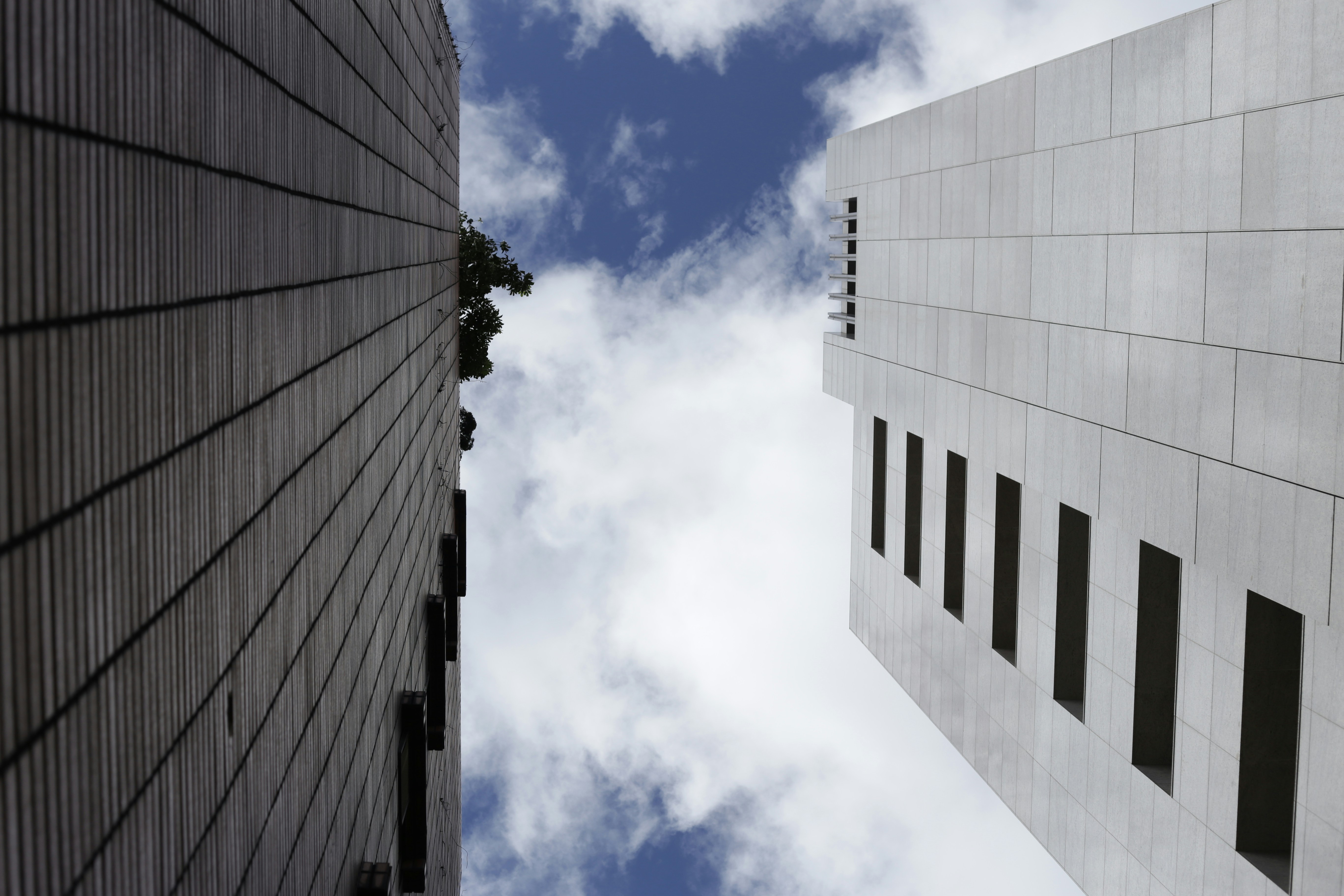 Gray concrete building under blue sky and white clouds during daytime ...