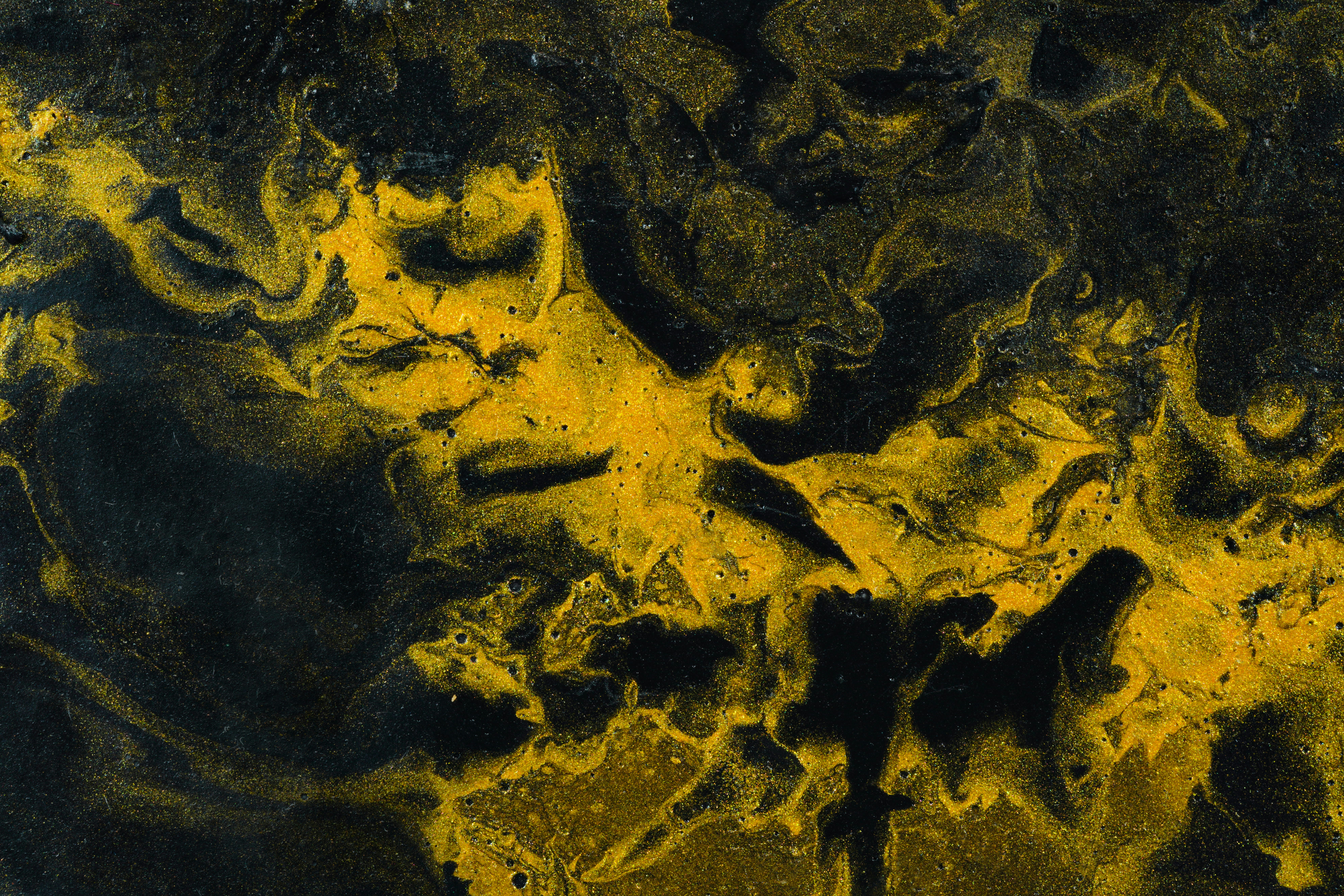 Abstract illustration showcasing swirling patterns of gold and black, reminiscent of a cosmic landscape. The interplay of colors creates a dynamic visual flow.