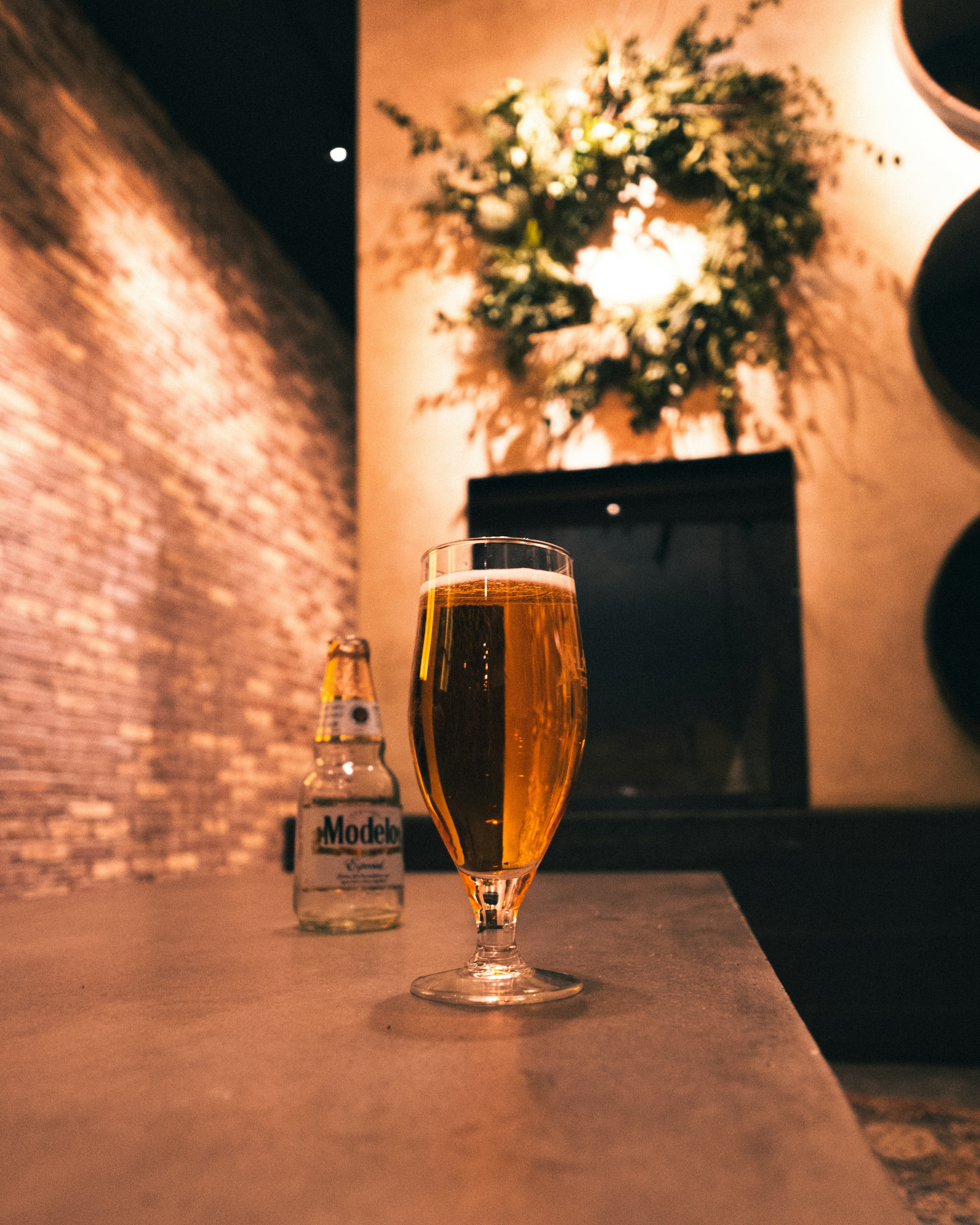 clear drinking glass with beer on brown wooden table