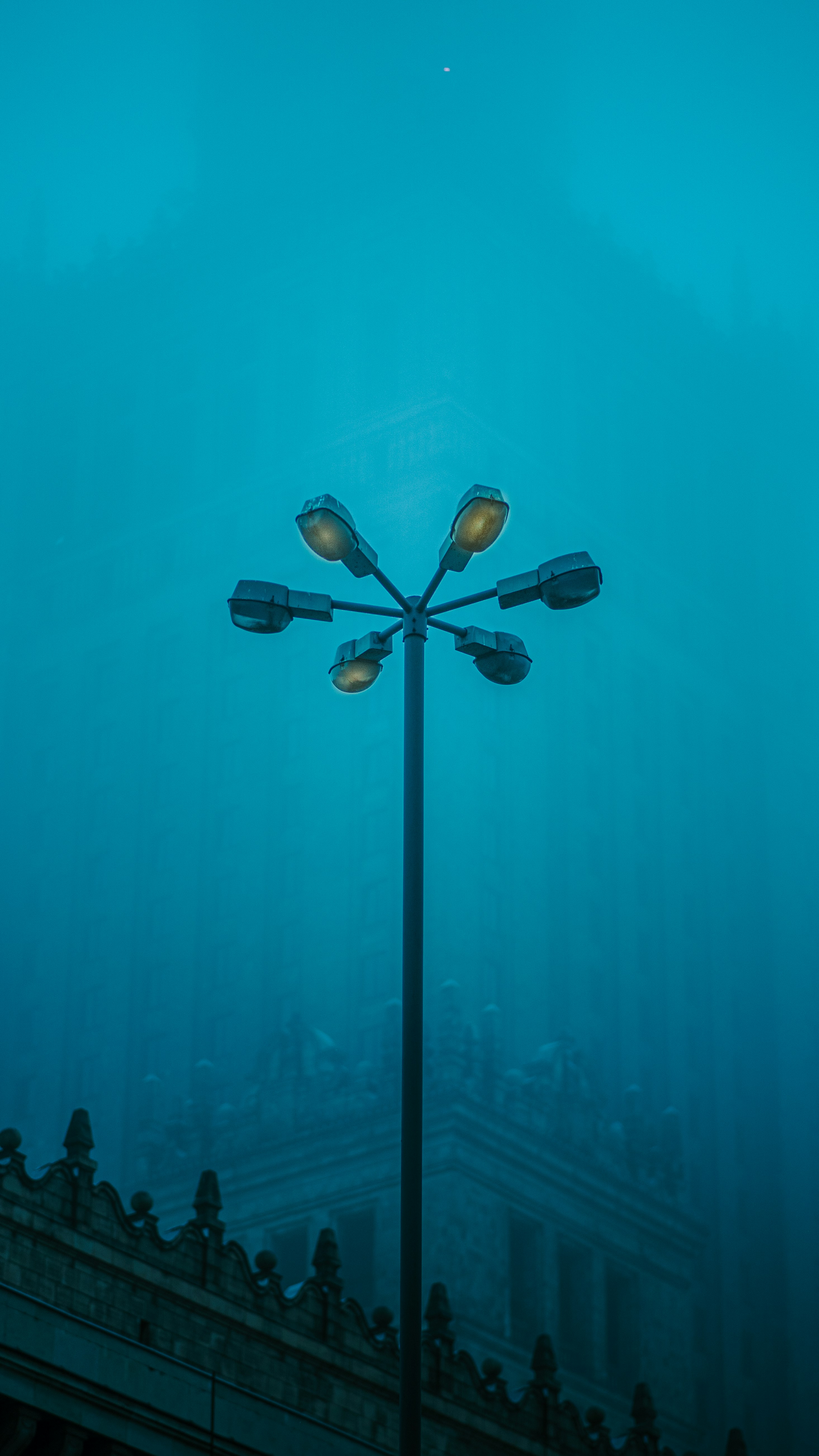 Black metal light post on blue wall photo – Free Blue Image on Unsplash