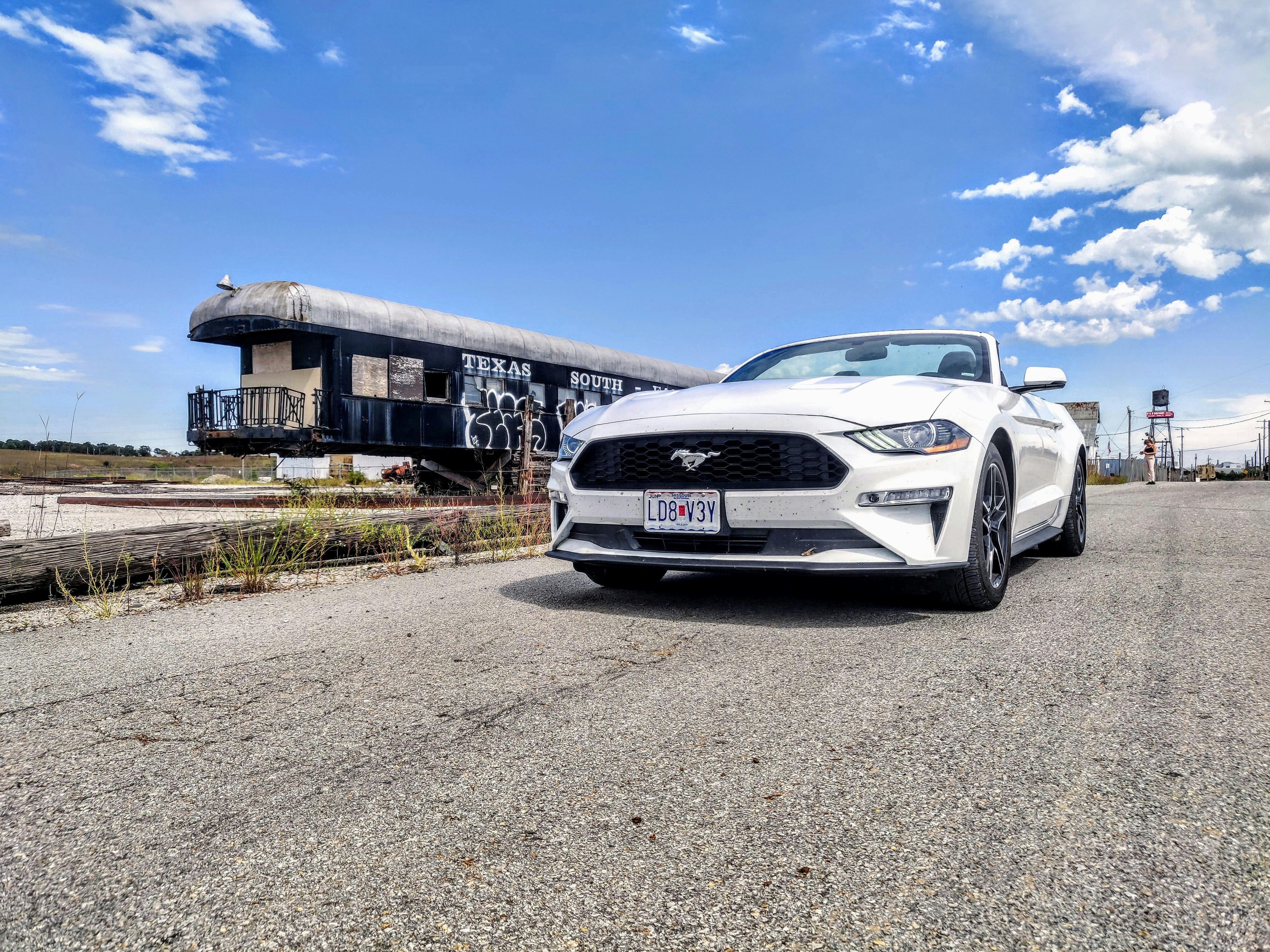 White Mustang at a Desolate Texas Roadside Diner Under an Expansive Sky