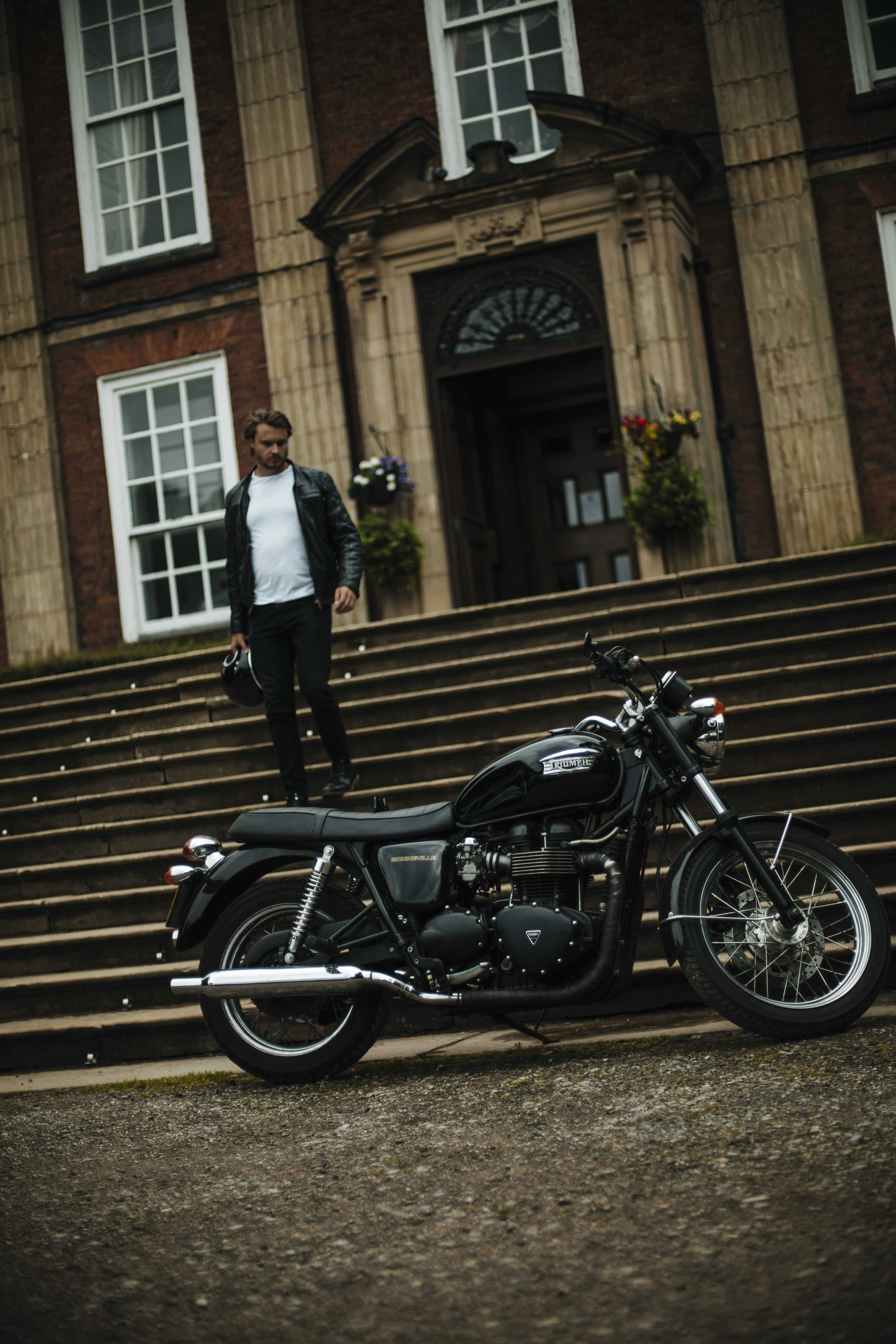 Noir Triumph by the Stairs: A Quiet Moment in Front of a Stately Entrance