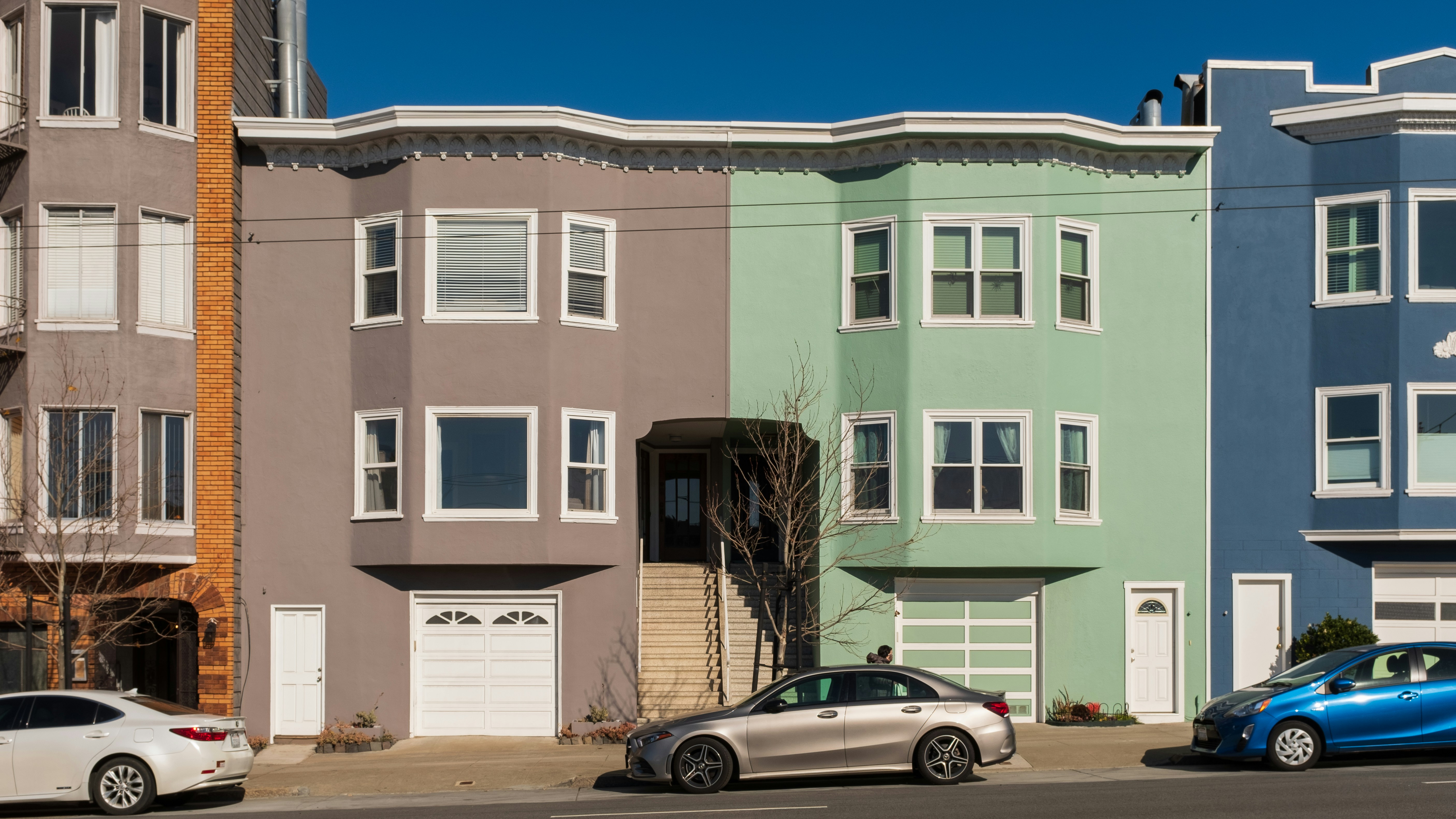 Laurel Heights | silver sedan parked in front of brown concrete building during daytime