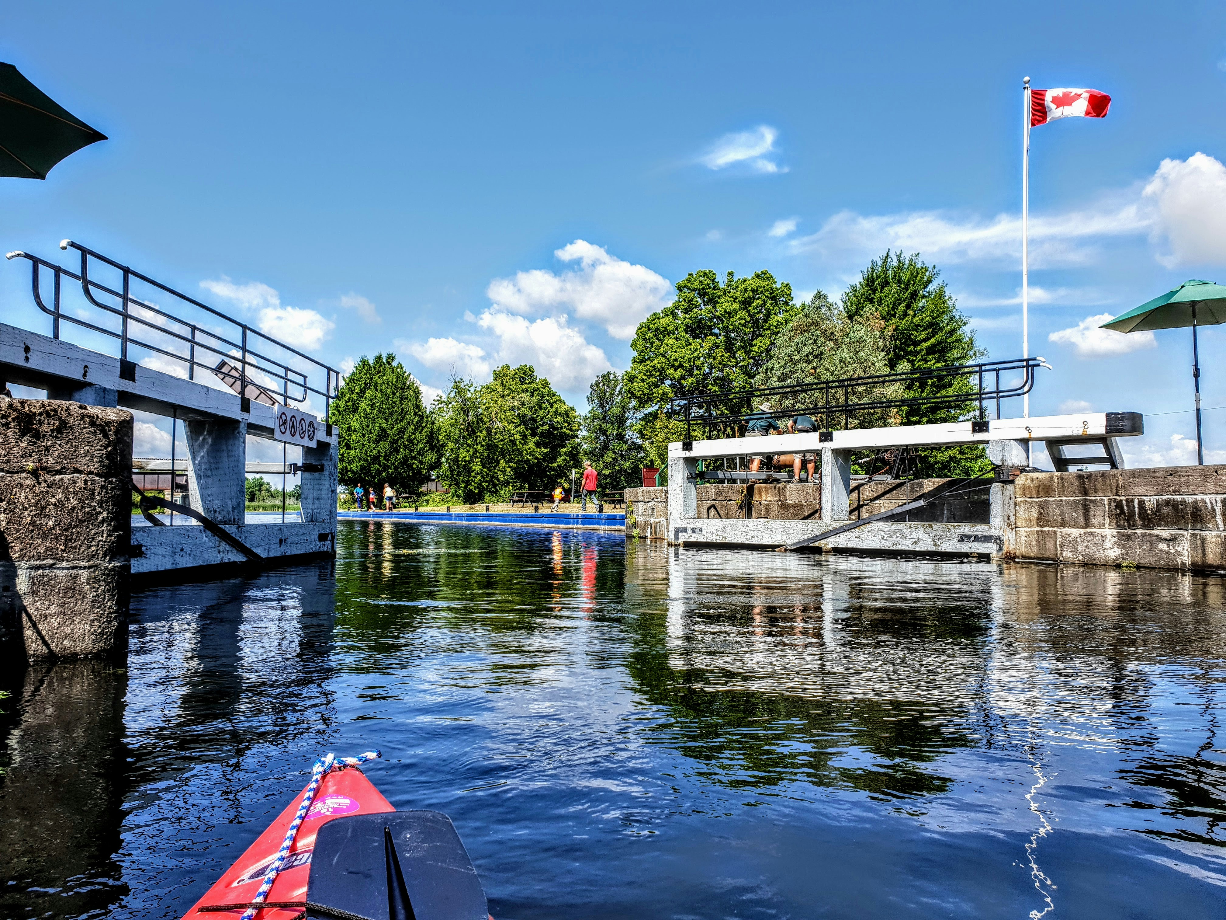 white and brown wooden bridge over river during daytime
