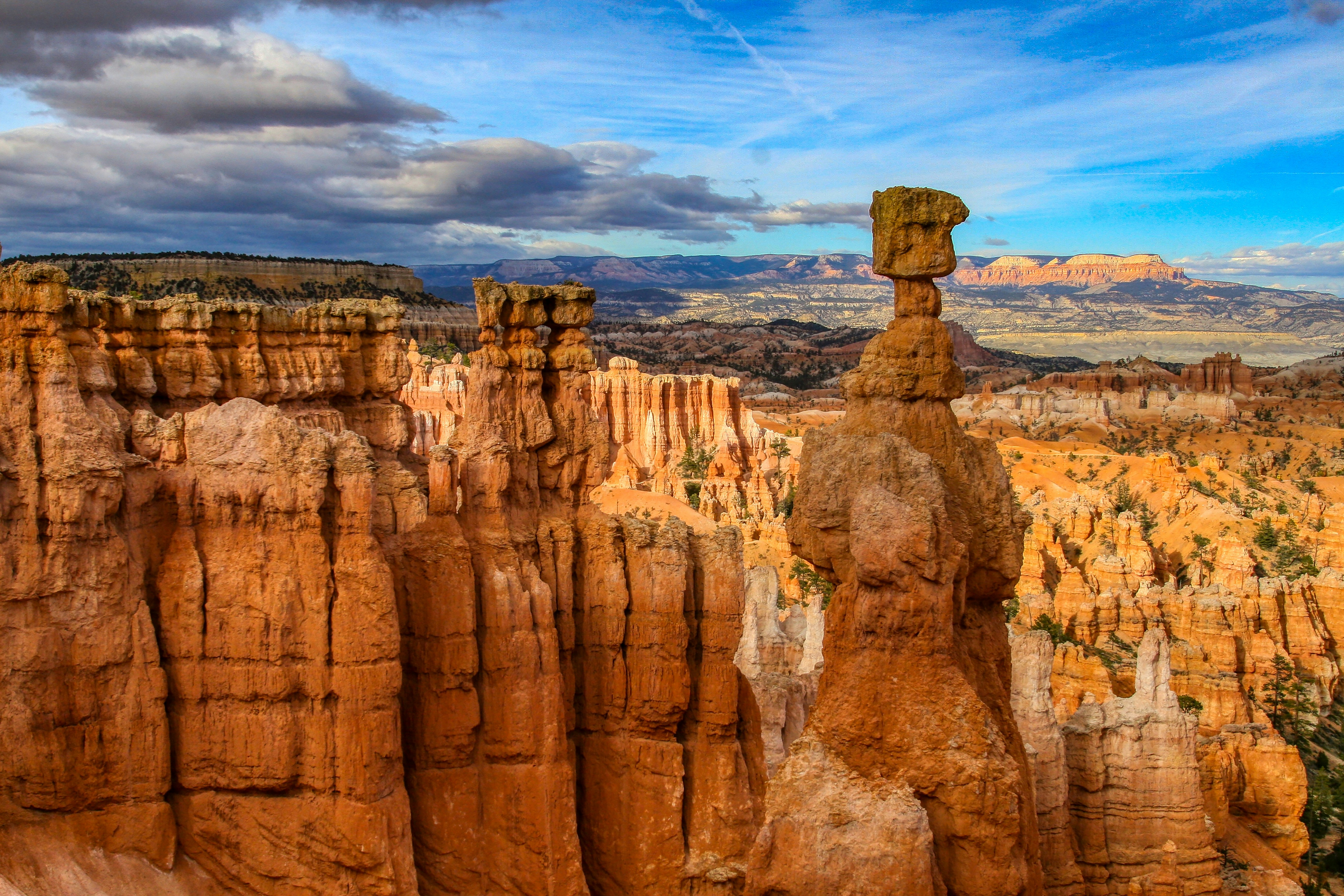 Towering hoodoos with intricate formations under a vibrant sky in Bryce Canyon.