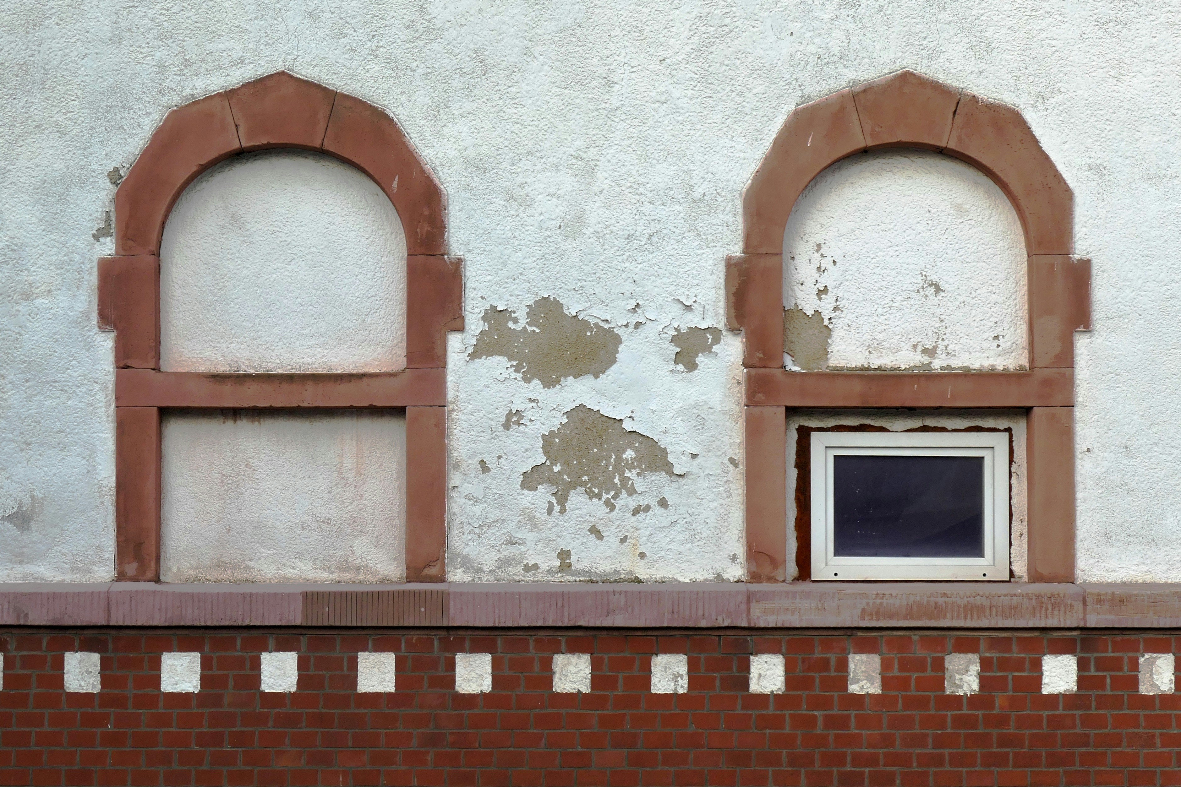 brown brick wall with white framed glass window