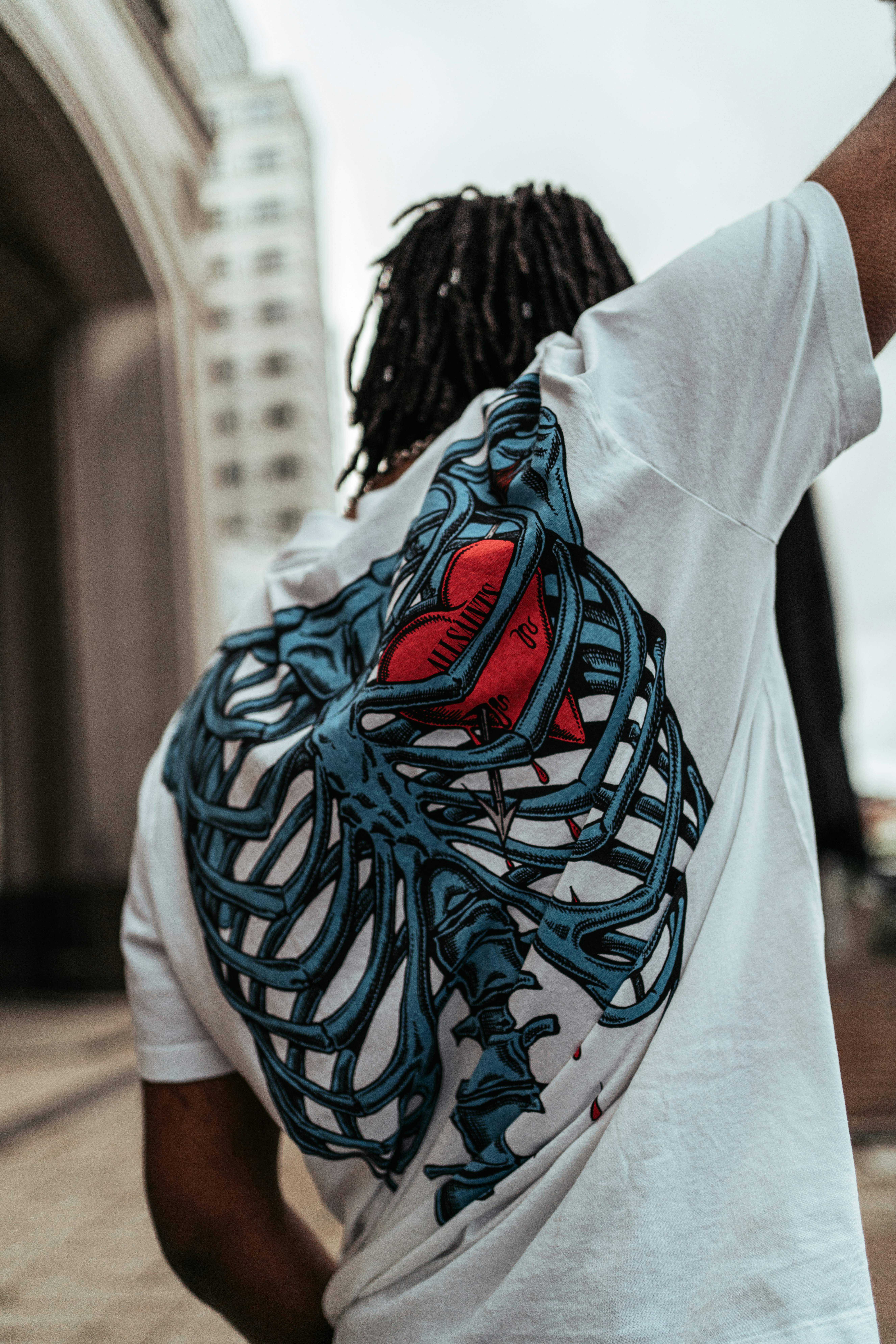 Skeleton Blueprint on a White Tee Amid City Streets
