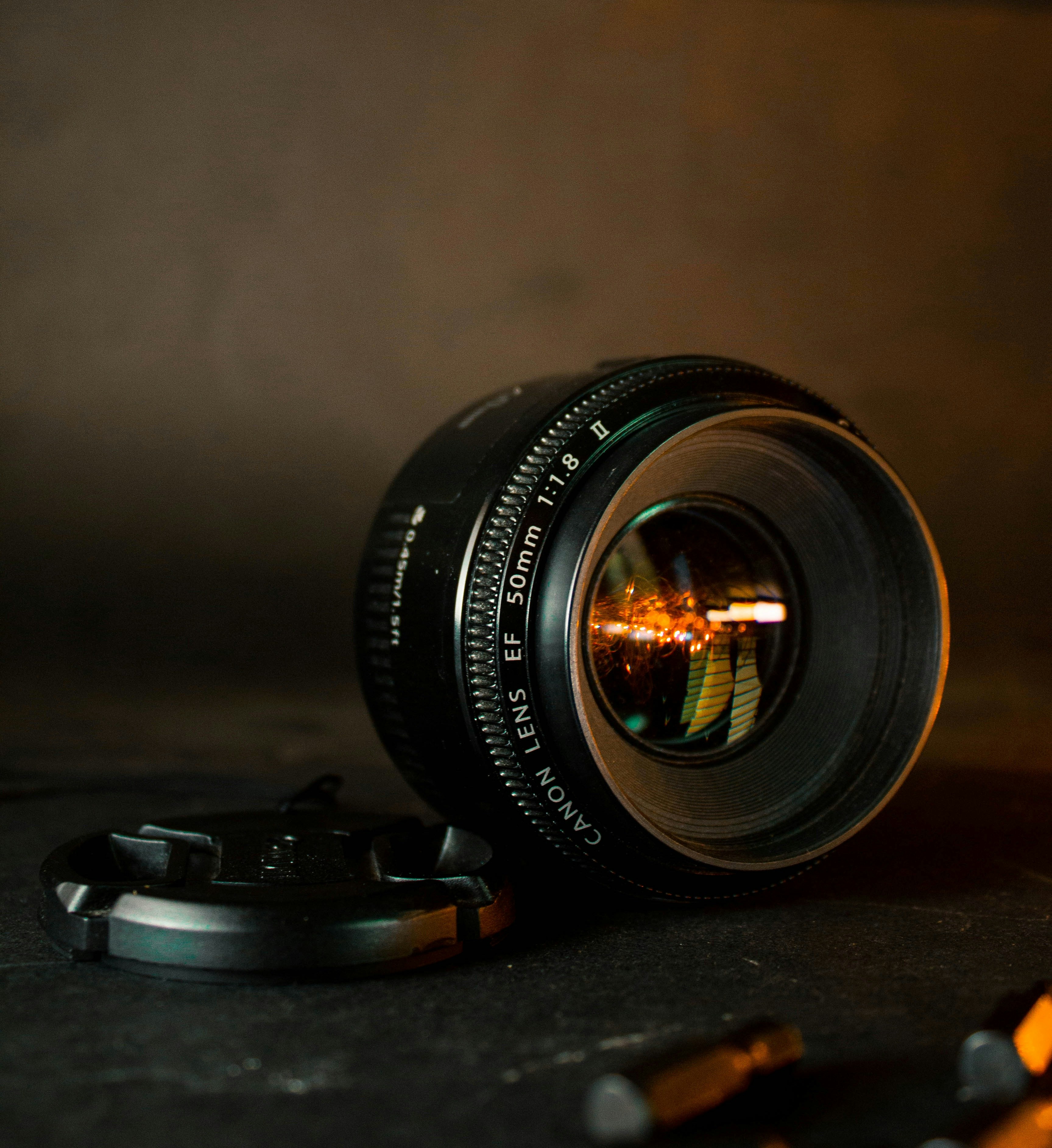 Black camera lens on brown wooden table photo – Free Camera lens Image ...