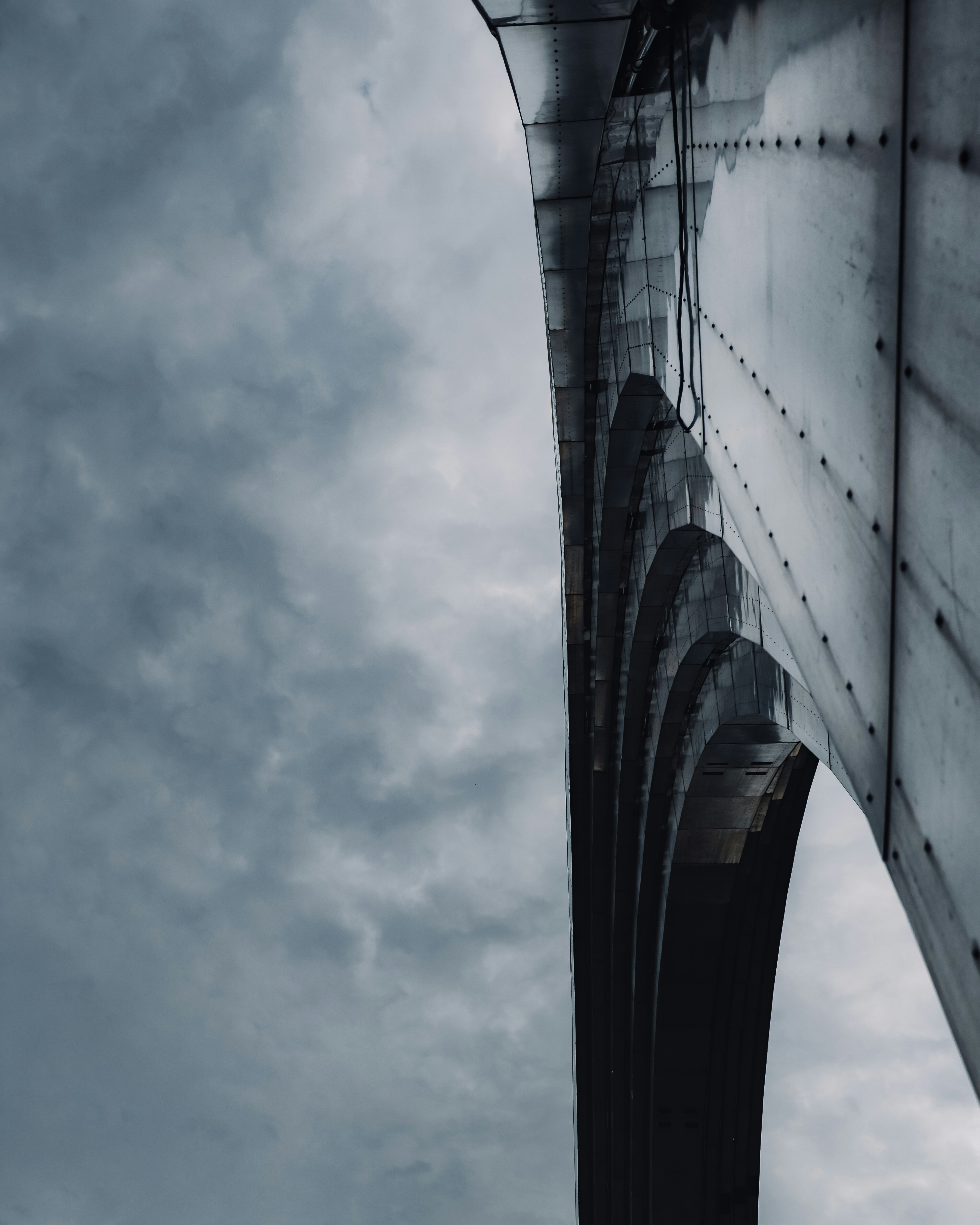 Riveted Arc: The Steel Bridge Carving Sky