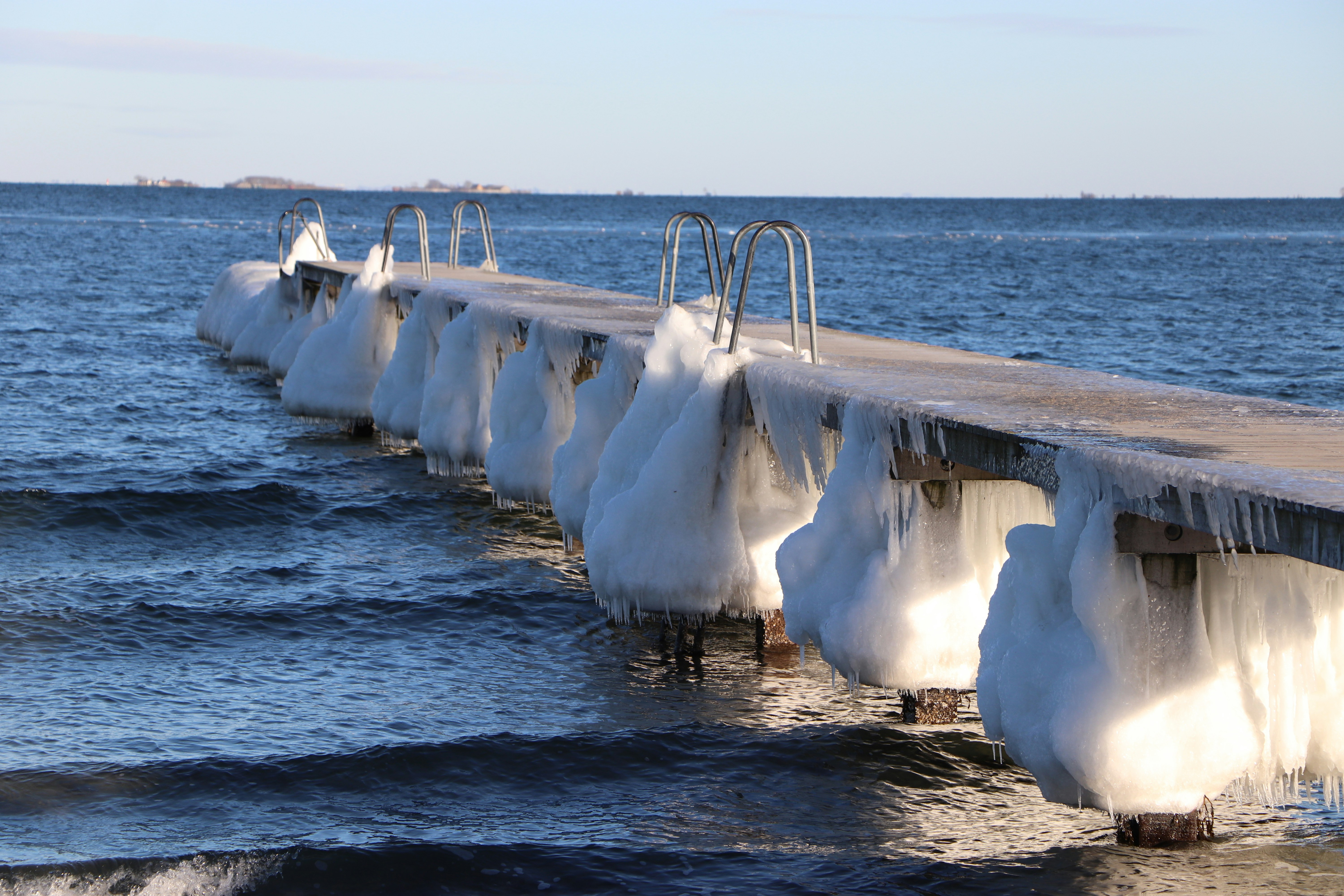 Icicle Cascade along a Wind-Scarred Pier over Cold Waters