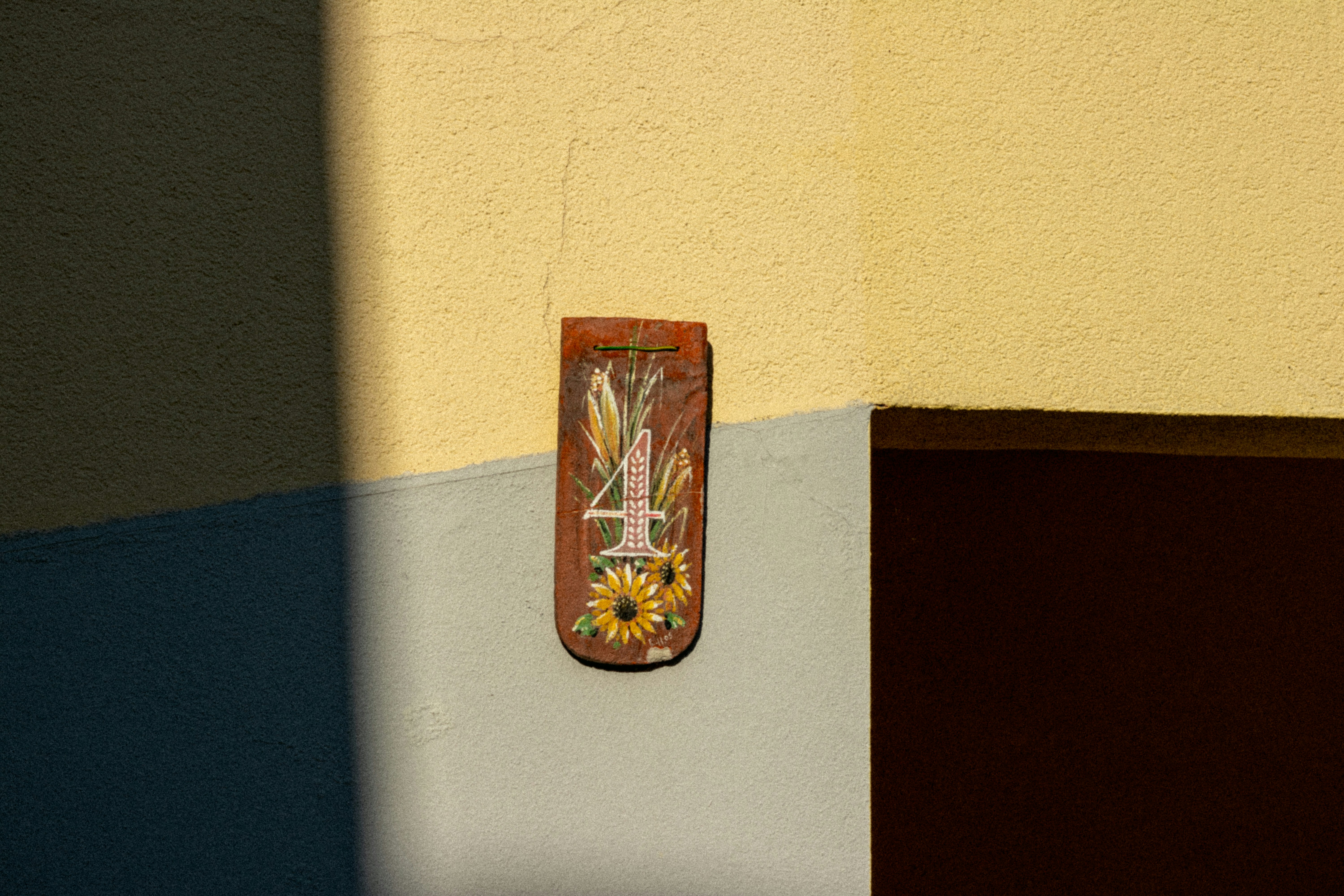 Sunflower Shield on a Two-Tone Facade with the Number Four