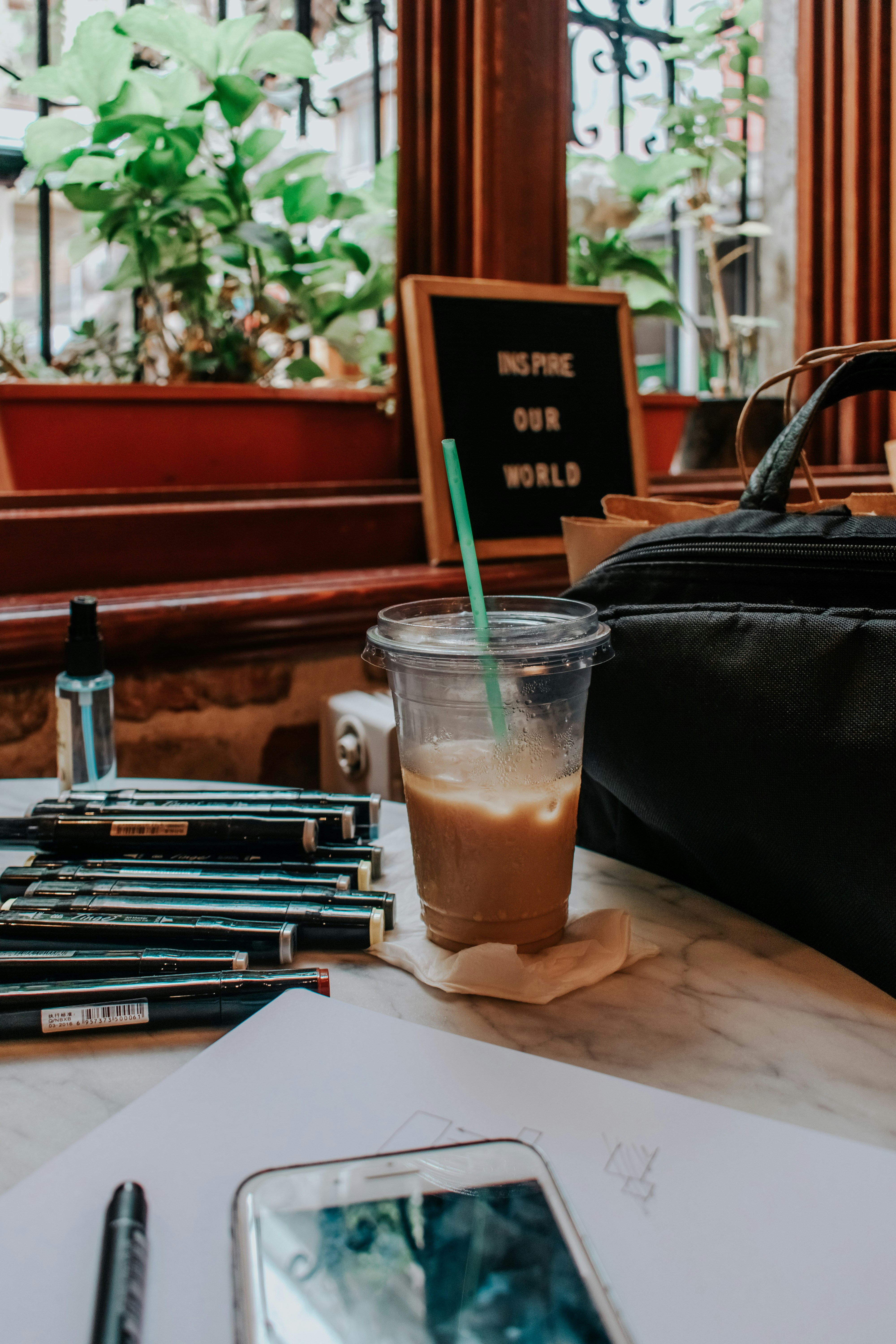 Iced Coffee and Sketches by a Window