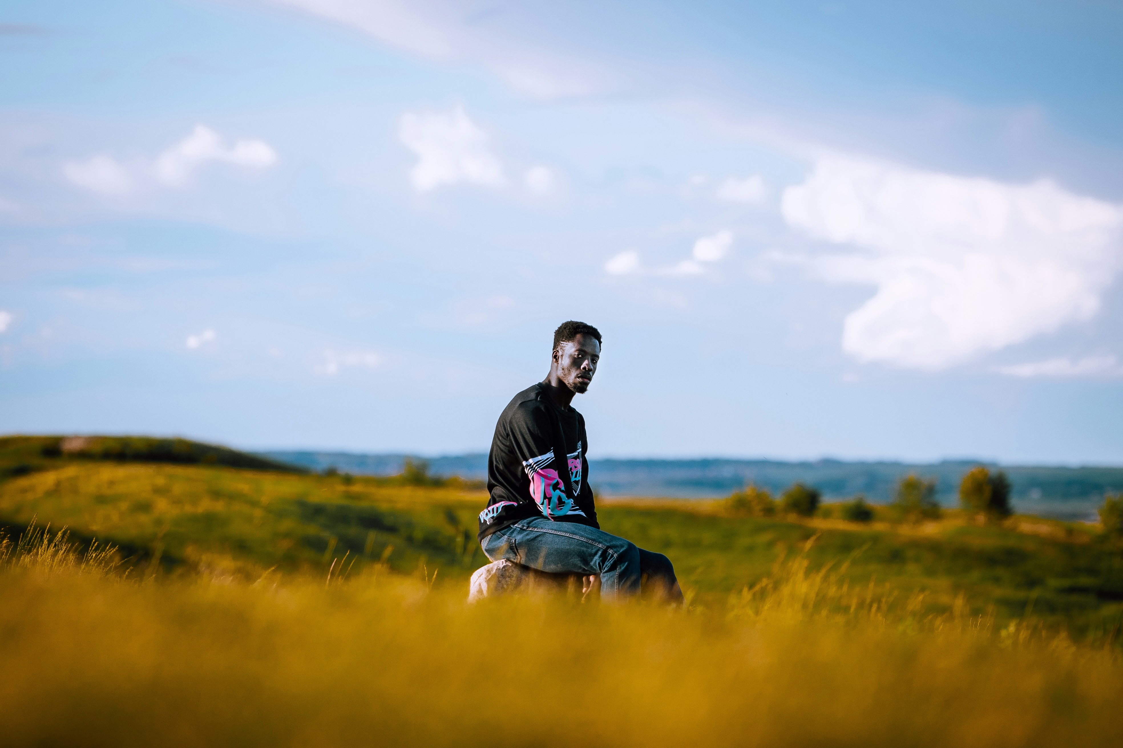 Amber Field Portrait: A Quiet Figure in Golden Grass Under a Vast Sky