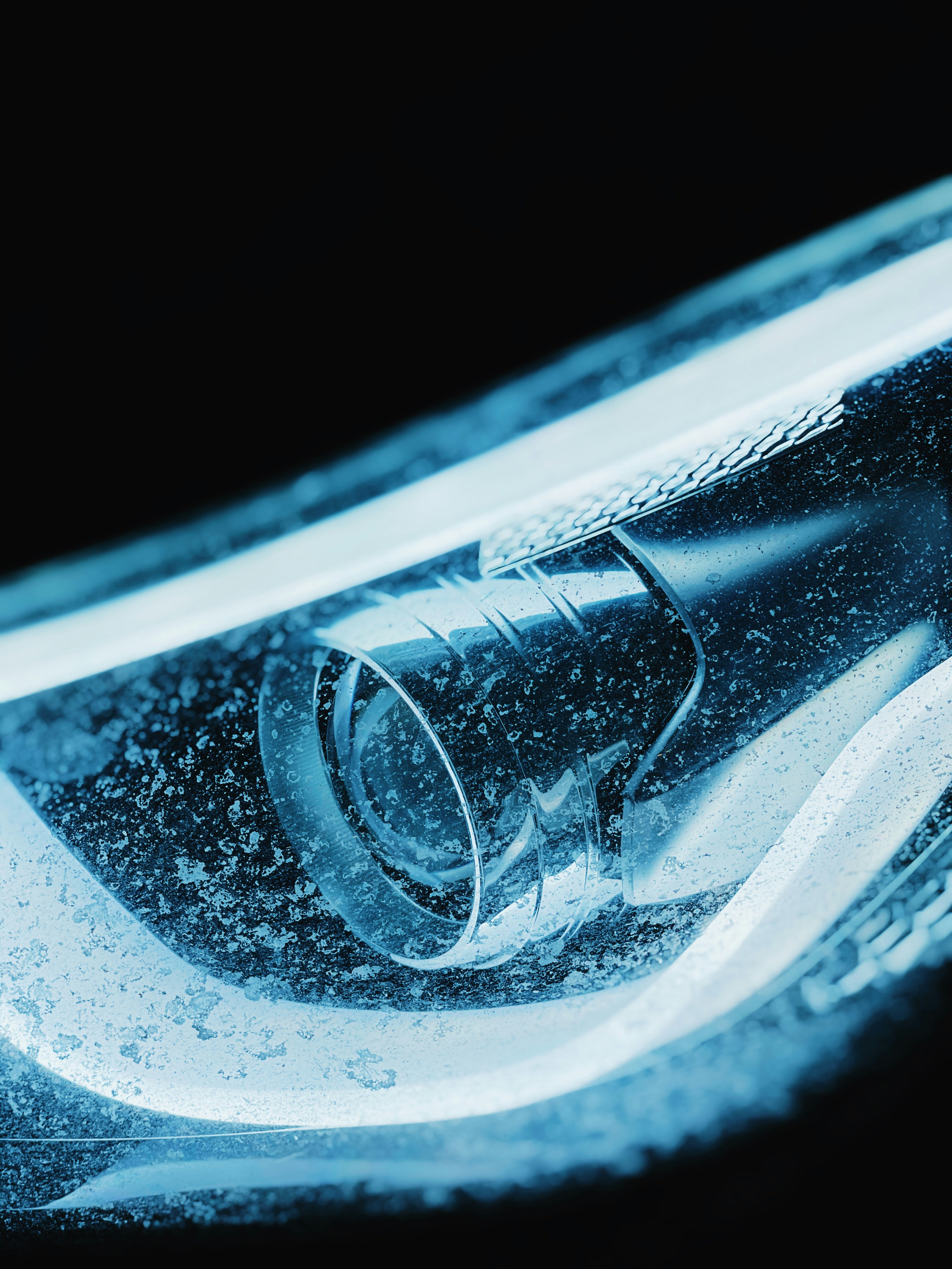 Frosted Halo: Macro Portrait of a Cyan-Tinted Car Headlamp