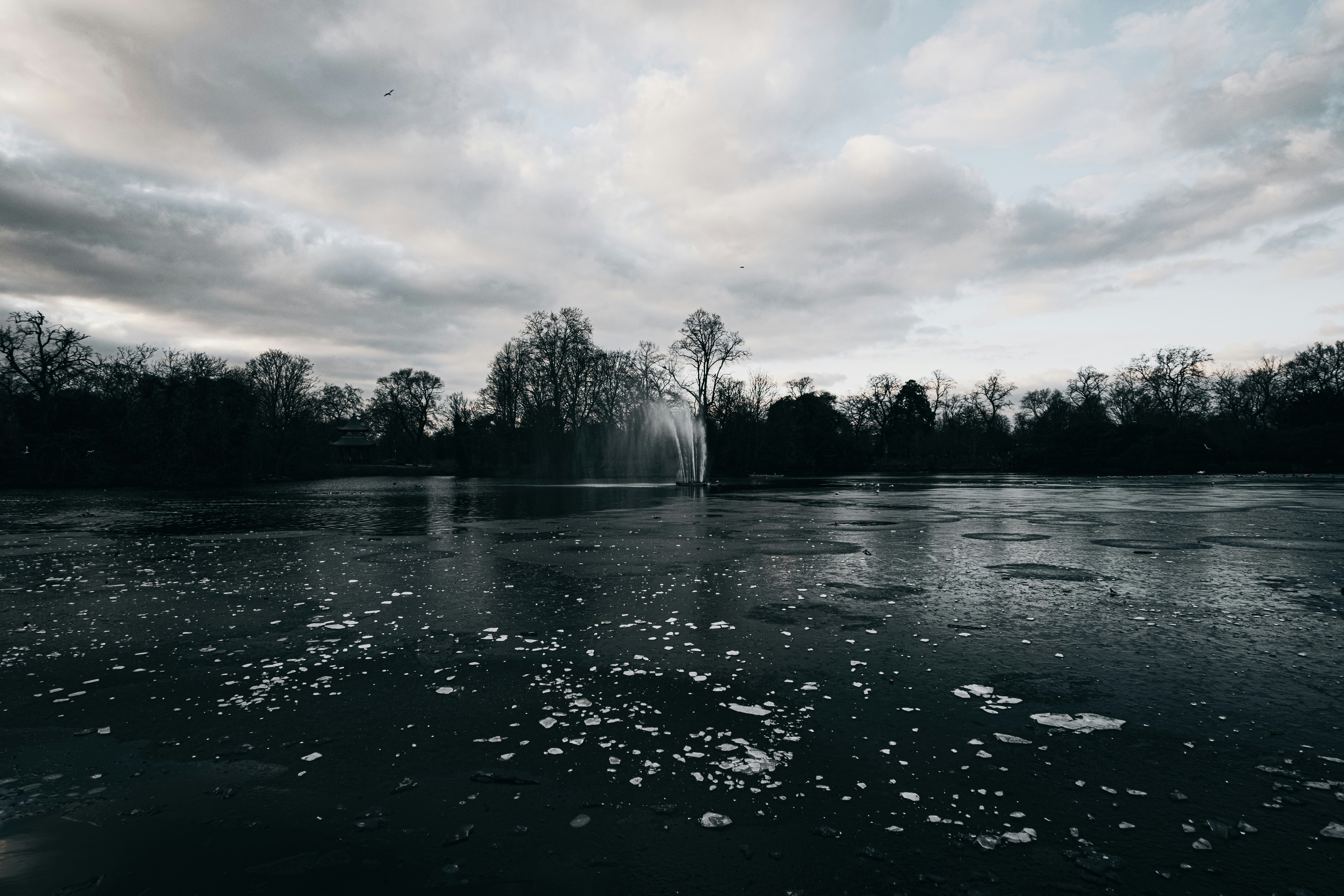 Fountain at the Lake: Quiet Geometry Under a Clouded Sky