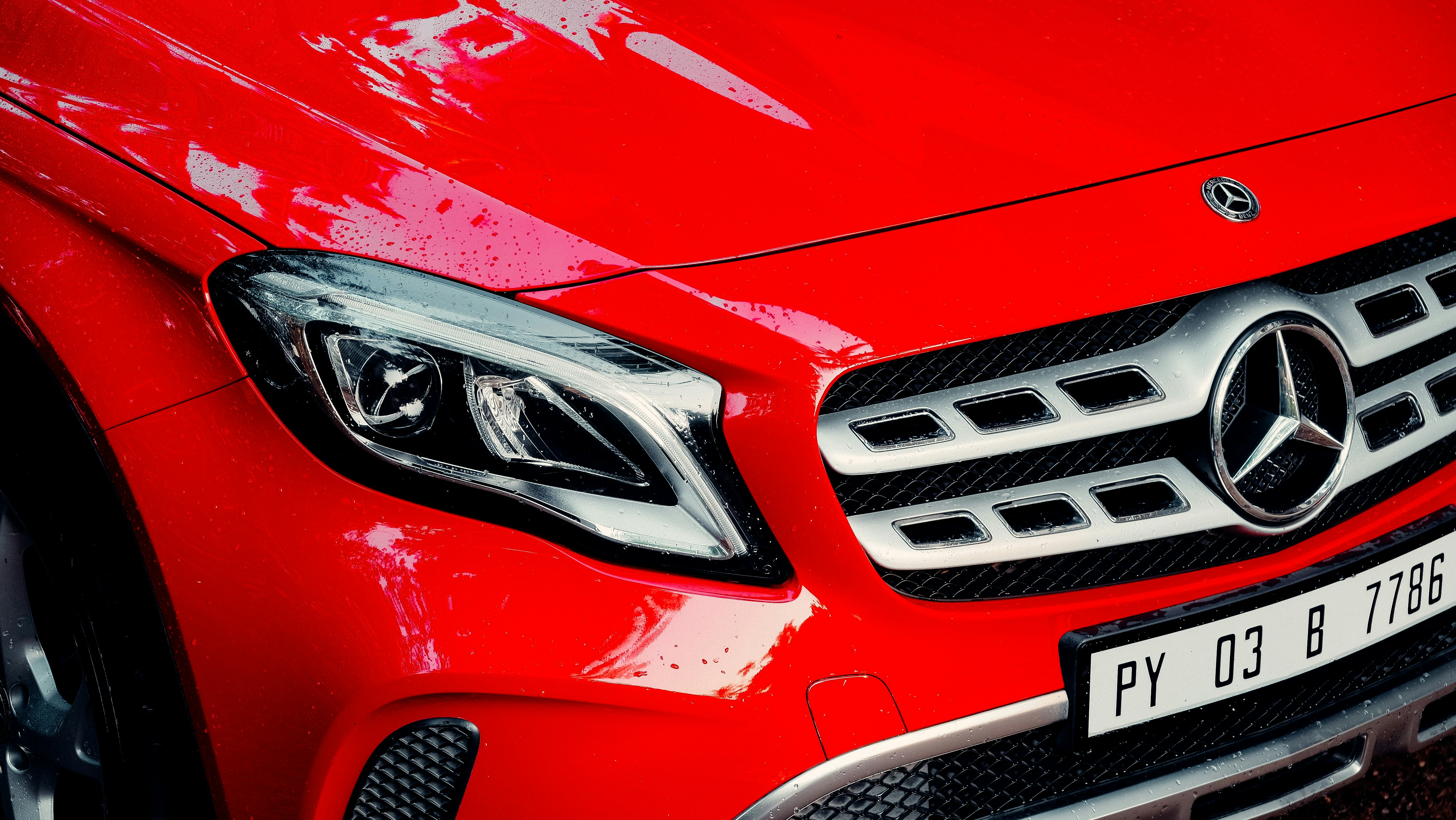 Close-Up of a Red Mercedes-Benz Front Grille and Headlight