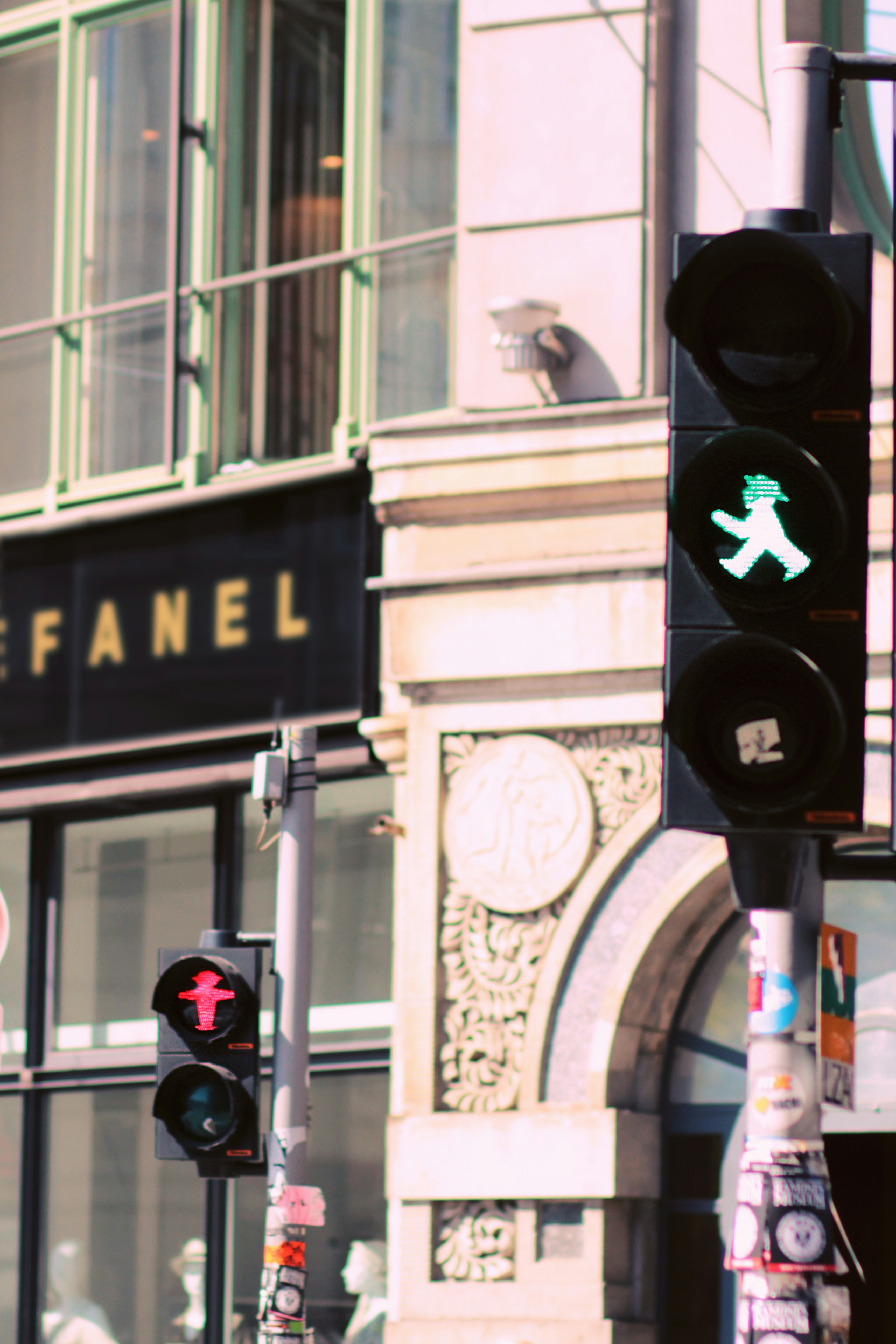 Green Pedestrian Signal Amid Ornate City Facade