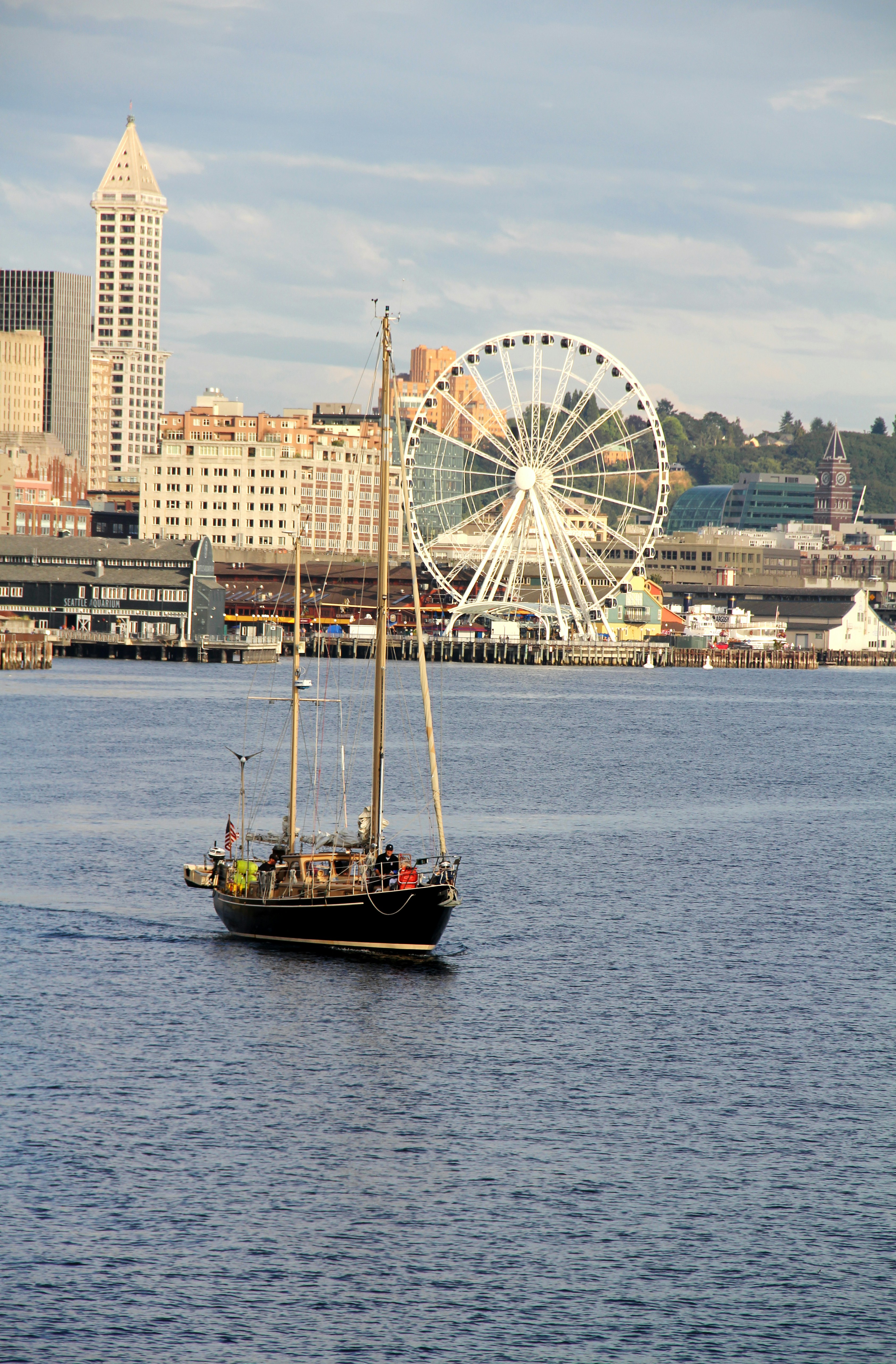 Sail Vessel Gliding Past the Waterfront Ferris Wheel