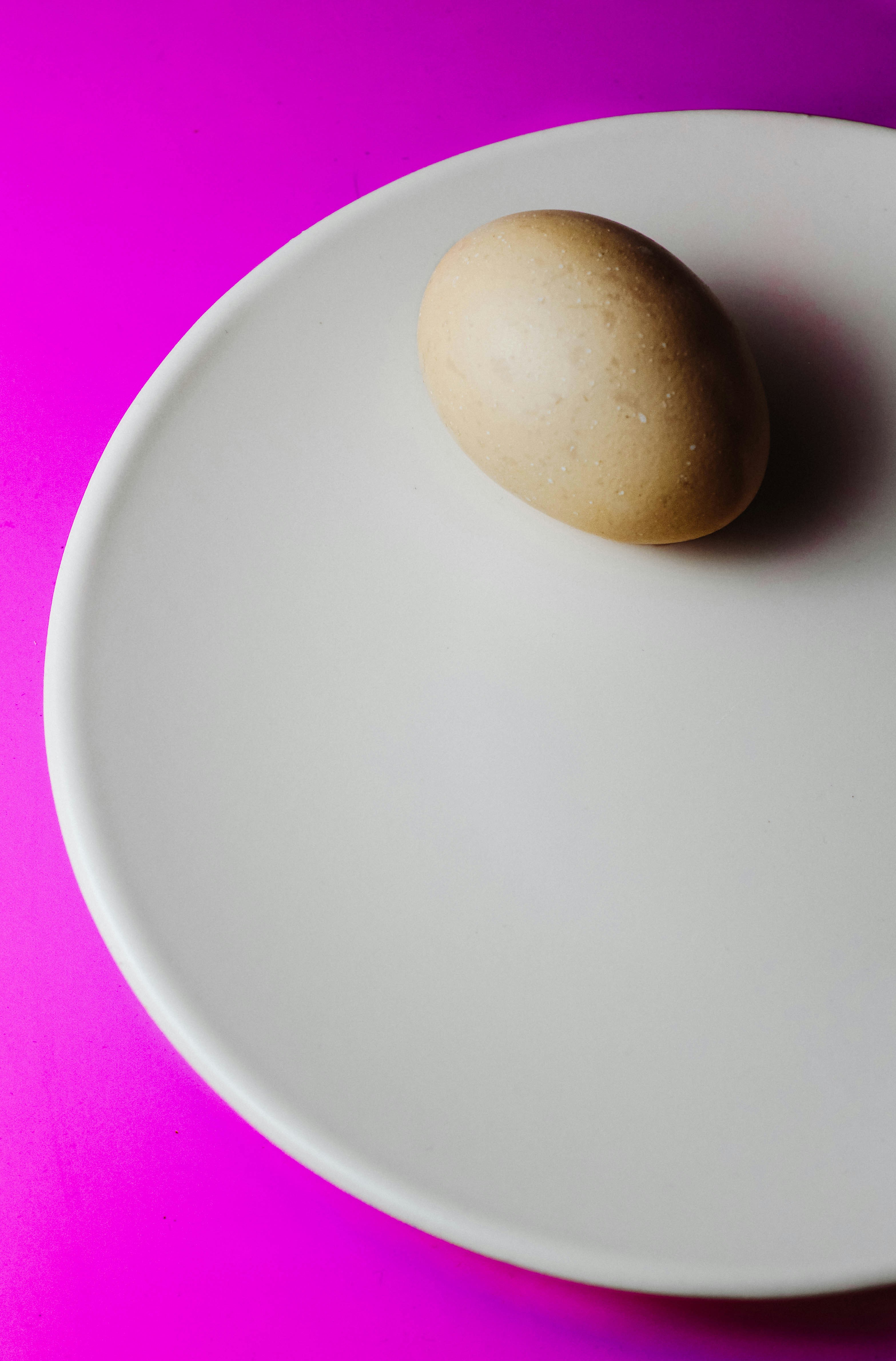 Amber Egg on a Magenta Stage: A Minimalist Still Life