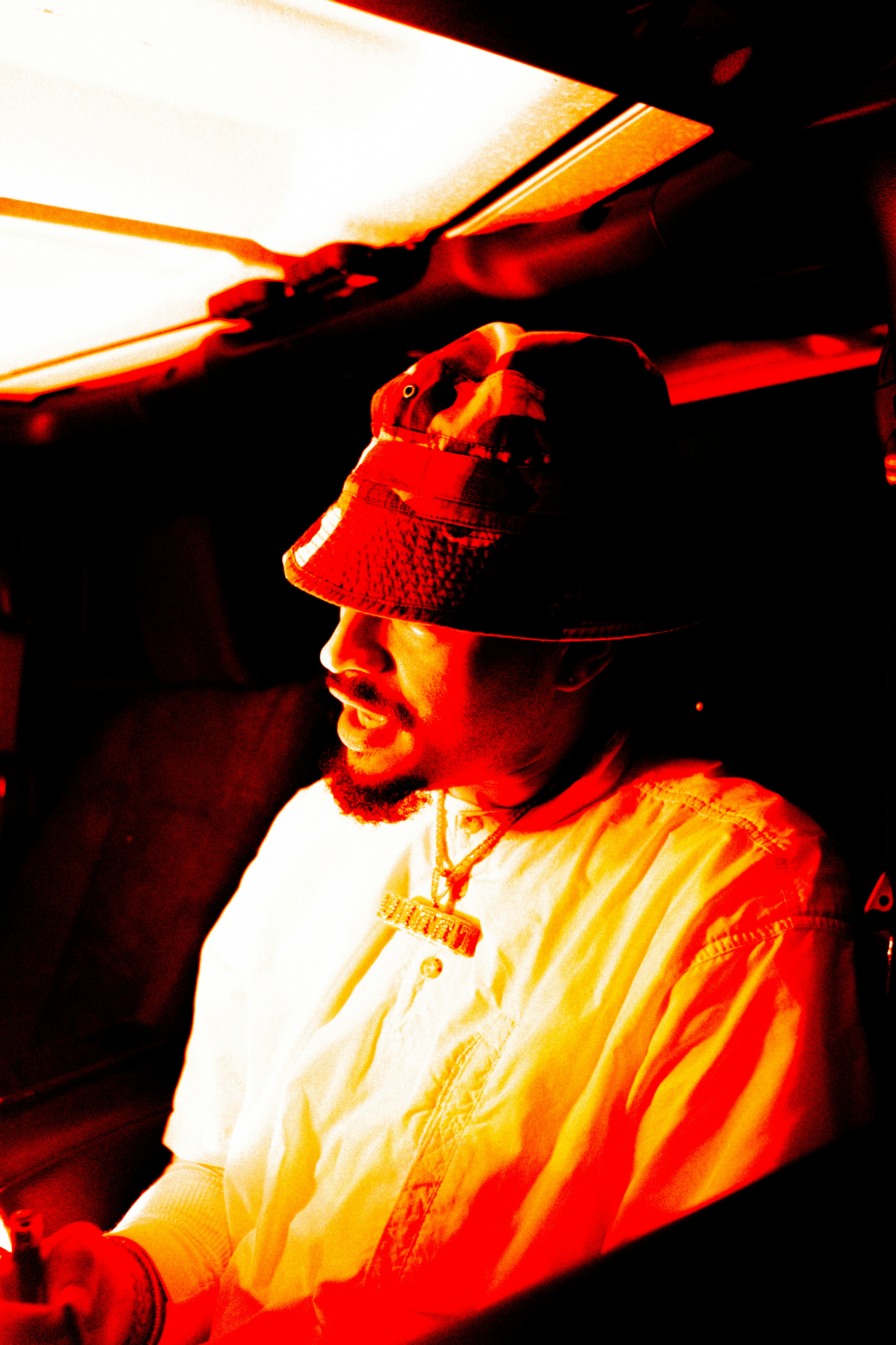 Crimson Cab Portrait: Neon Warmth in a Moving Interior