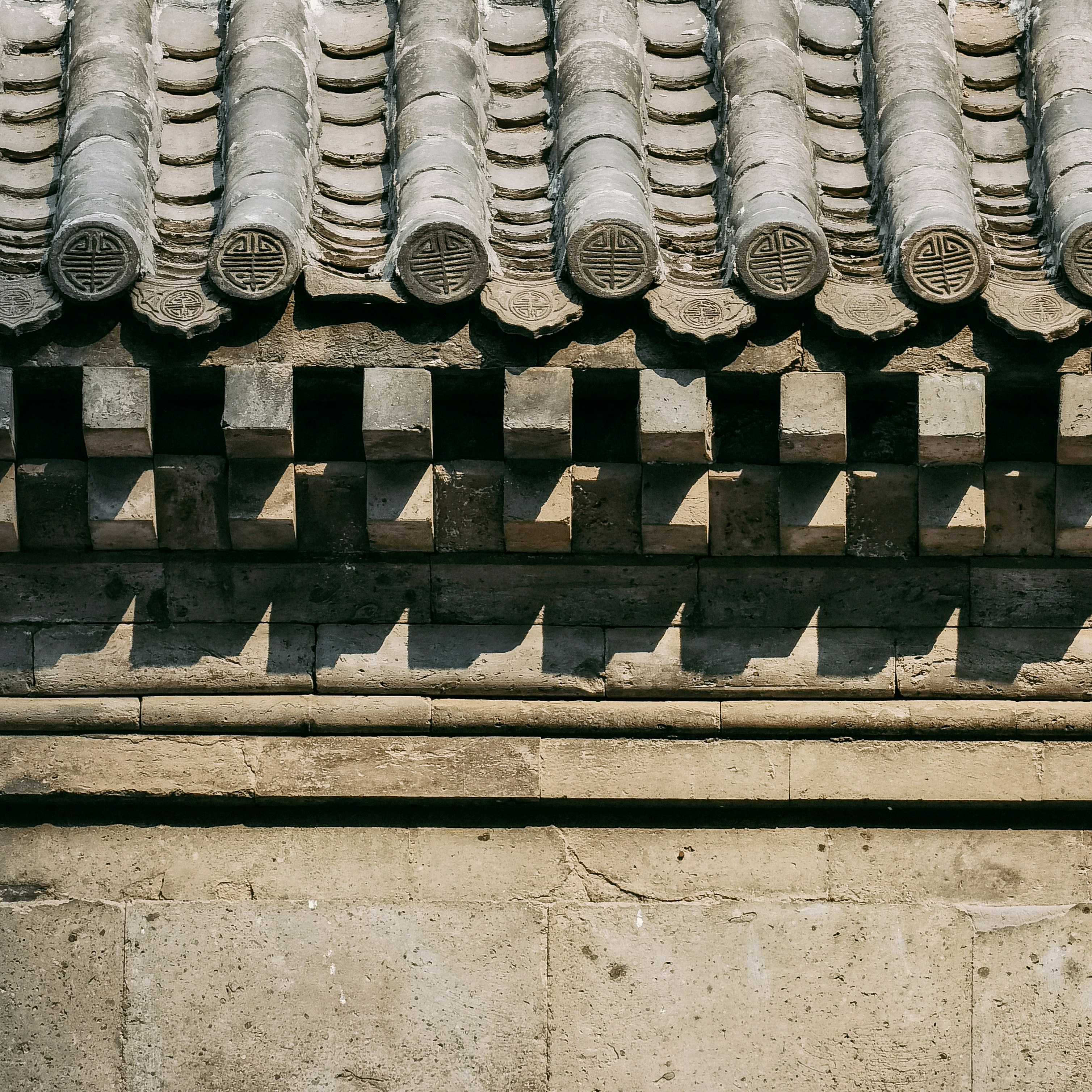 Intricate details of traditional tiled roofing showcasing craftsmanship and texture. The image highlights the architectural elegance of historical structures.