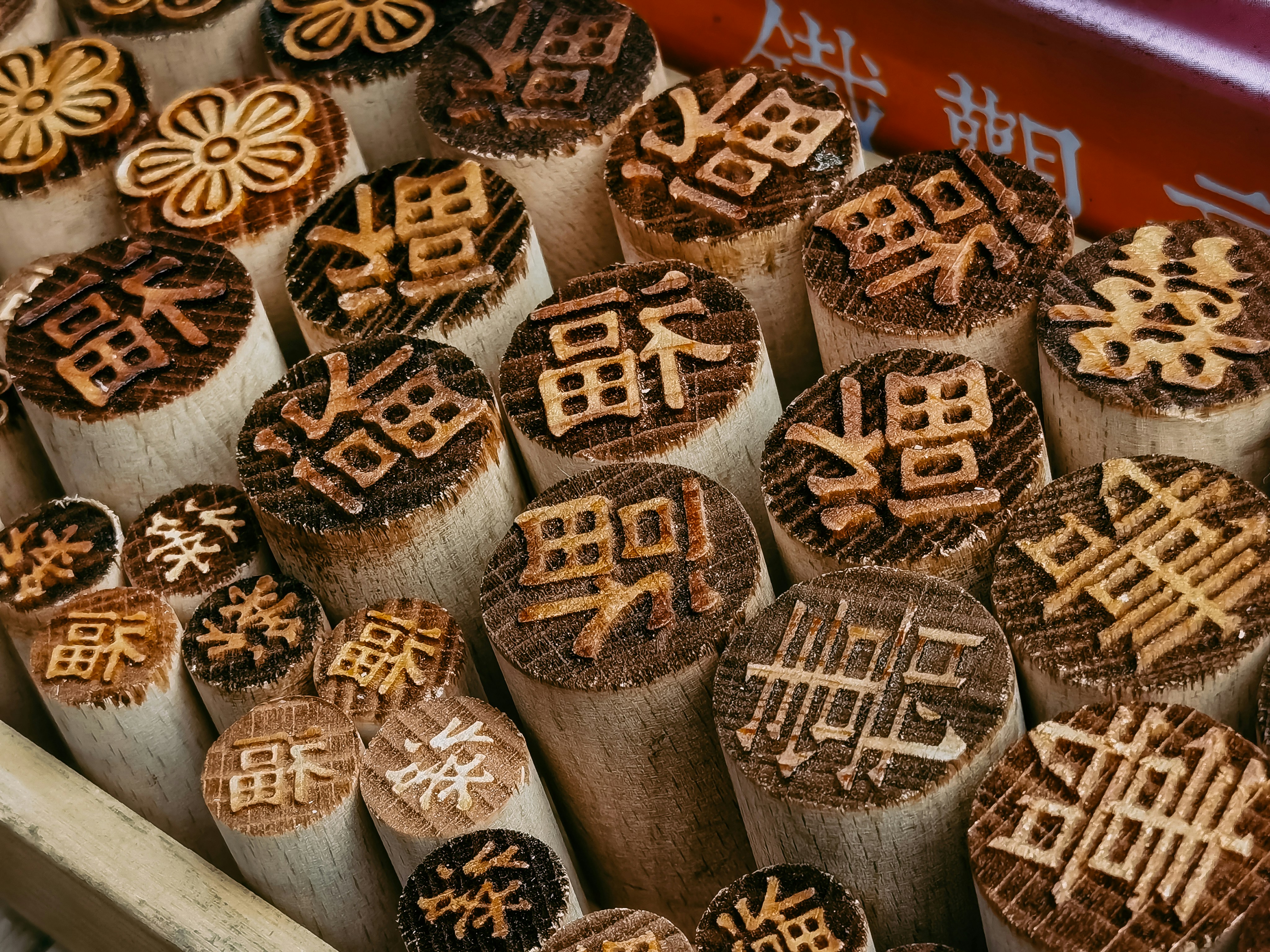 A collection of intricately designed wooden stamps featuring various symbols and patterns, showcasing traditional craftsmanship.