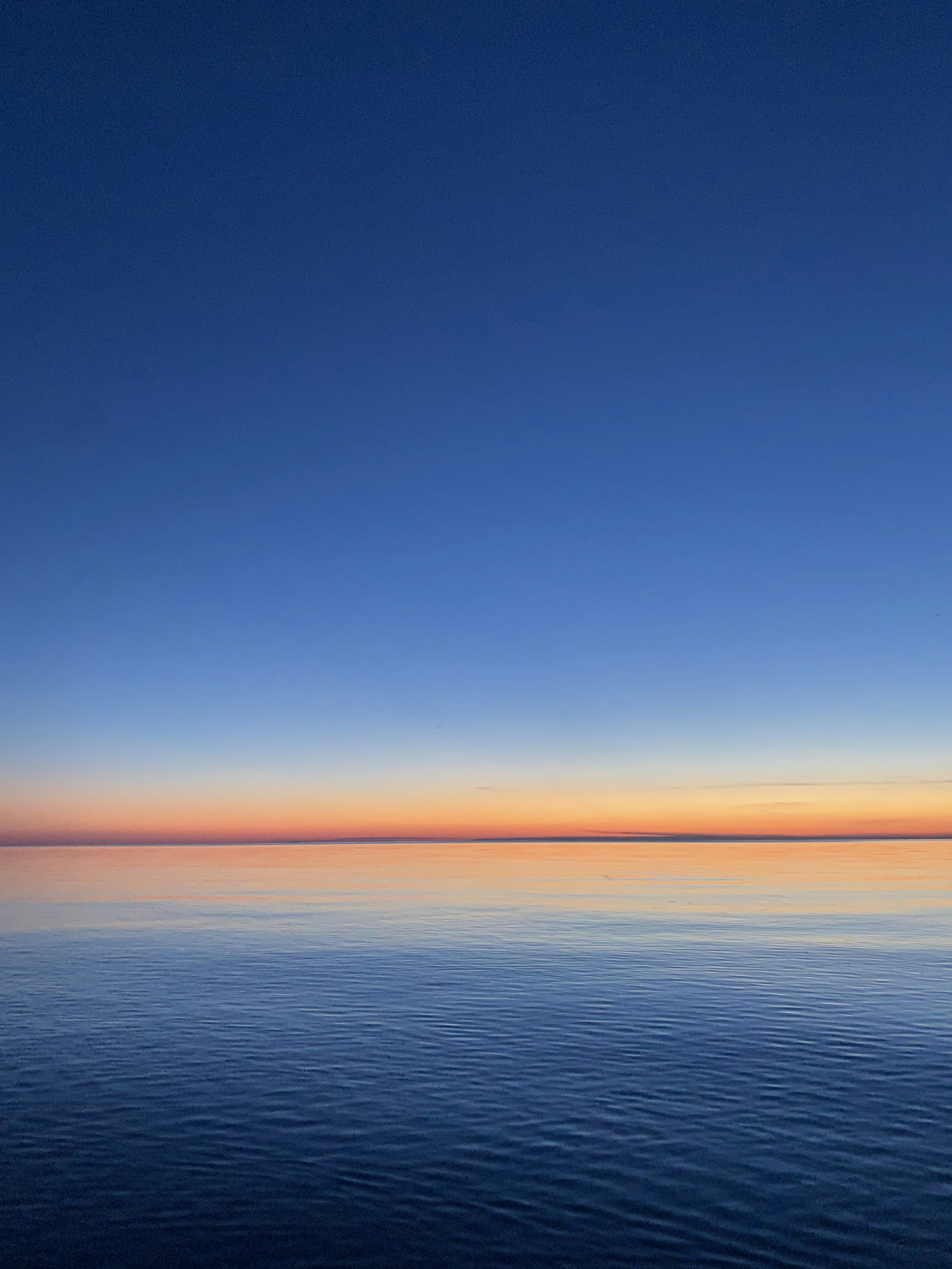 Sunset reflection  | blue sea under blue sky during daytime