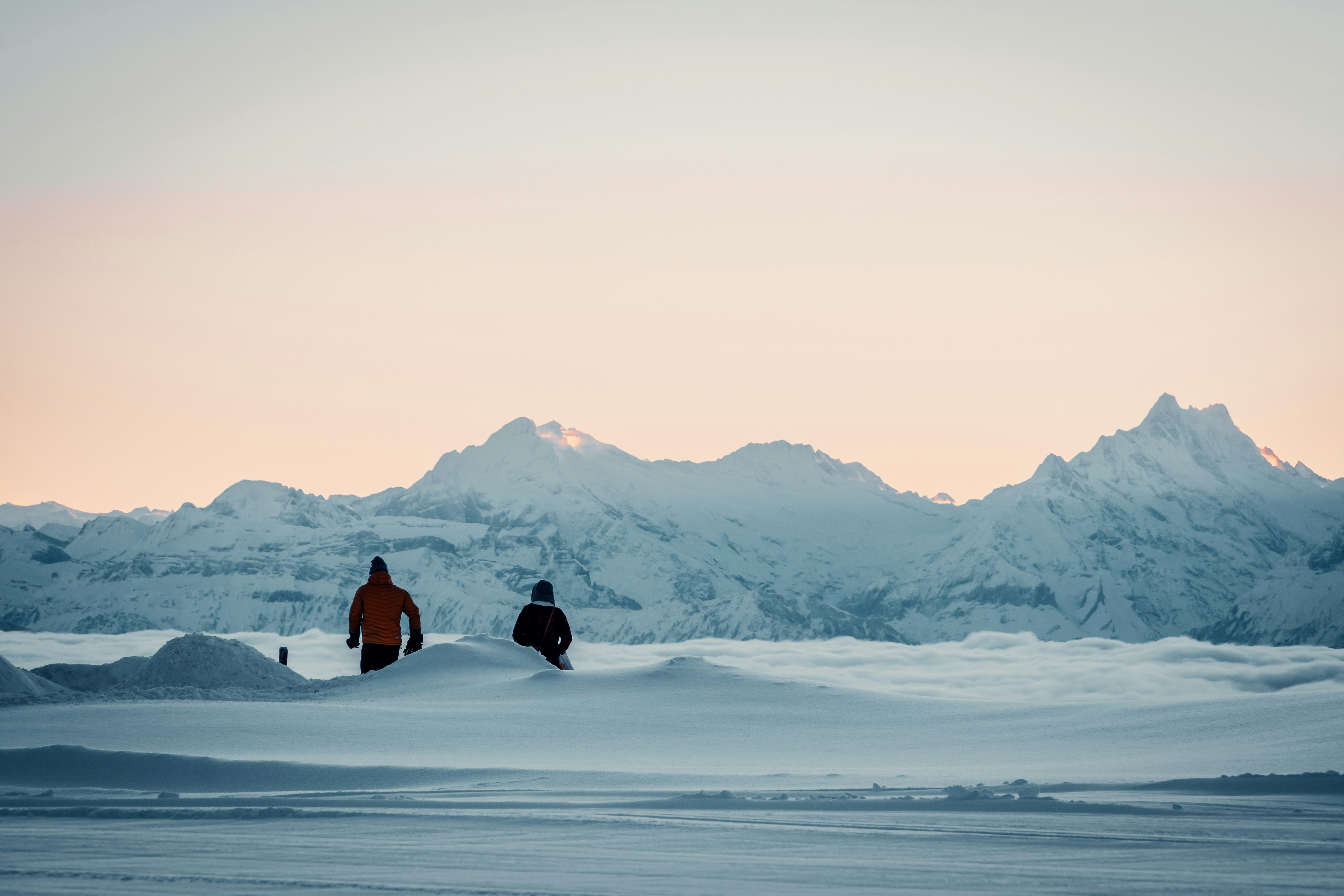 Dawn Trek Across Wind-Sculpted Snow Beneath Jagged Ice Peaks