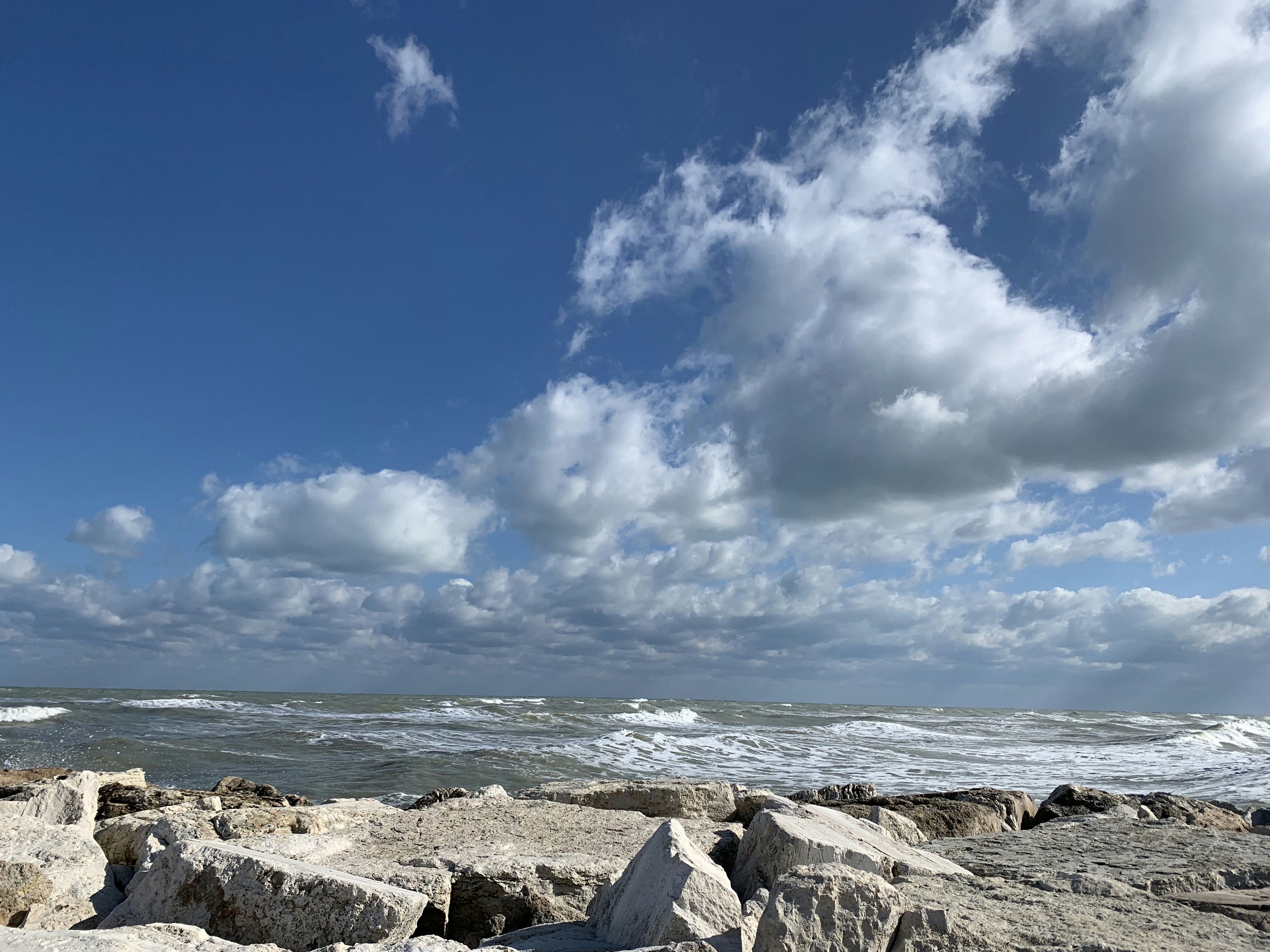 Cloud Symphony Over Rocky Shoreline