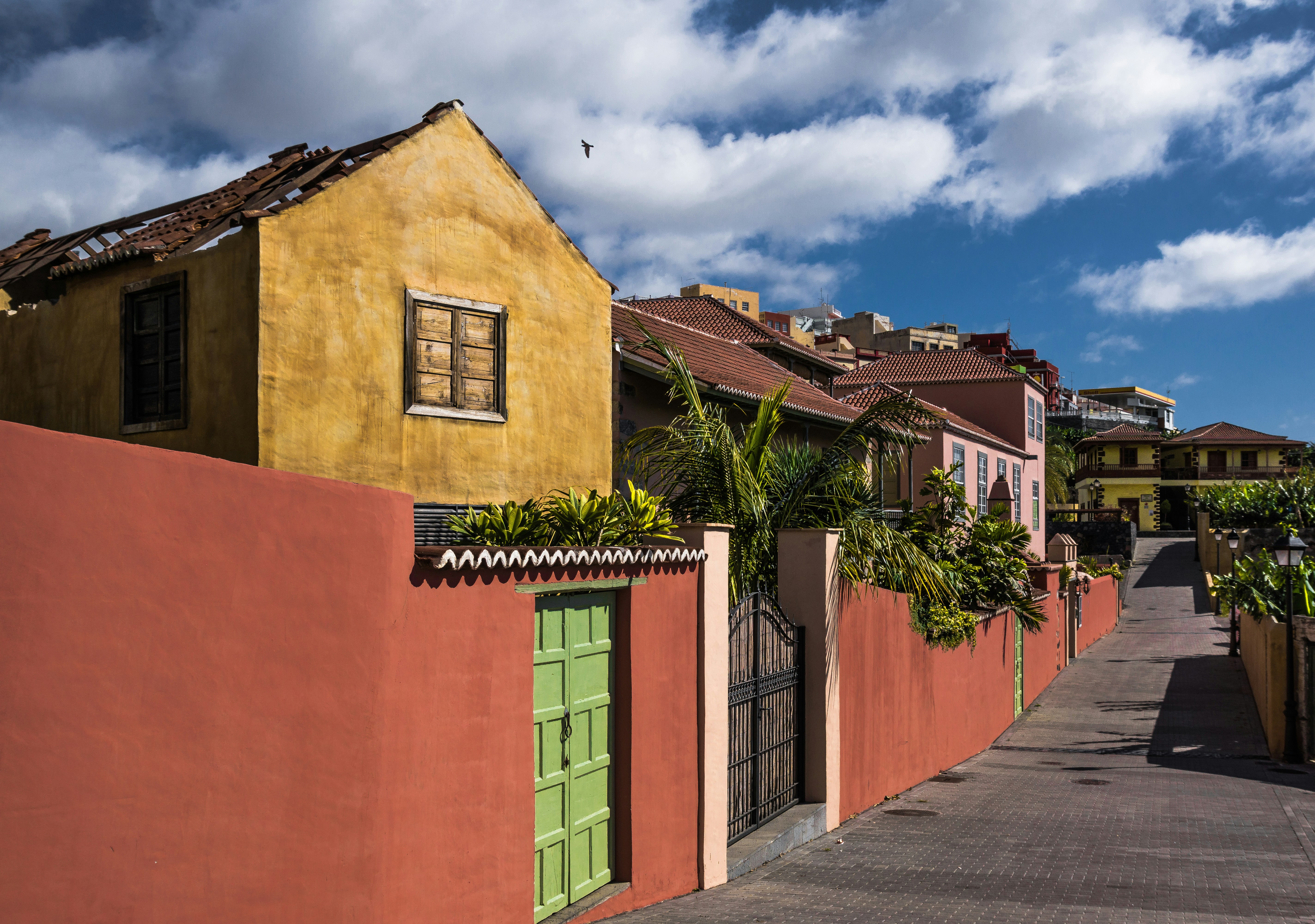 Pastel Corridor: A Sunlit Alley of Colorful Walls