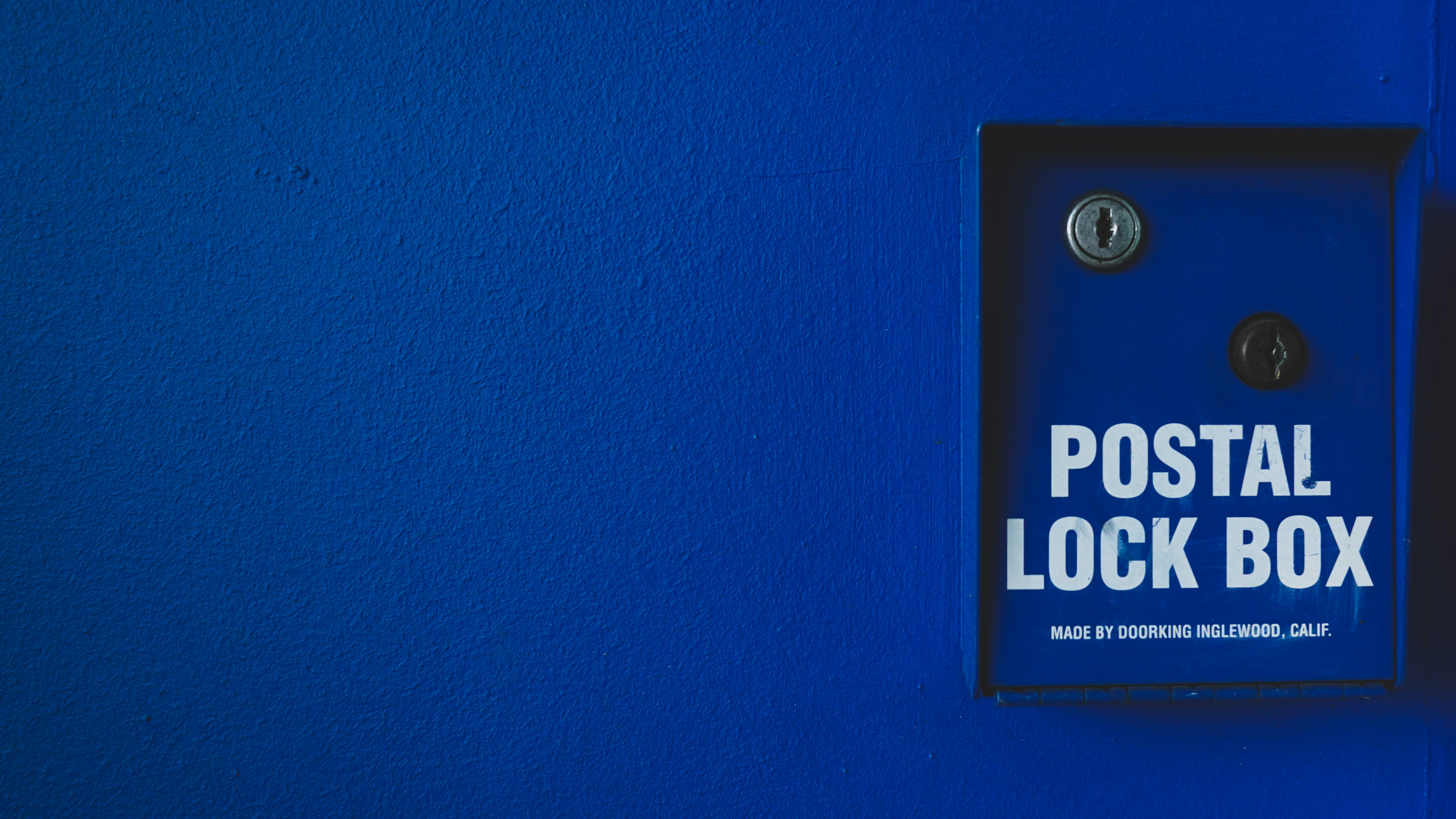 A blue wall with a sign that says postal lock box photo – Free Lock box ...