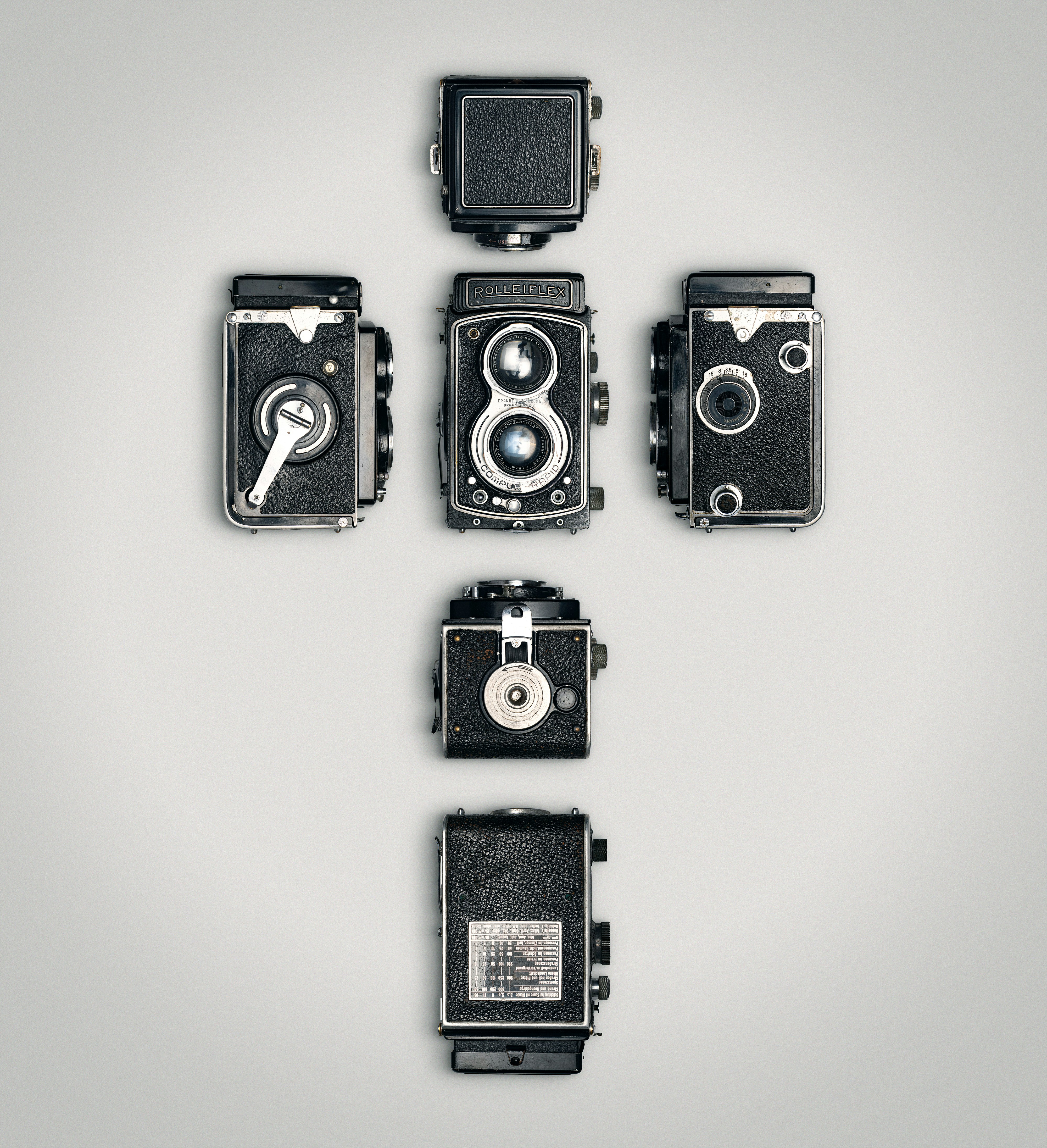 A Quiet Assembly: Vintage Box Cameras Aligned in a Monochrome Grid
