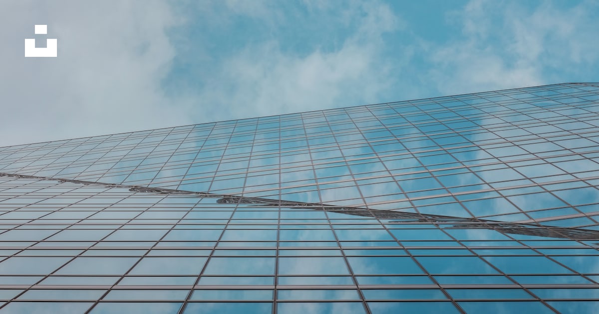 Blue And White Glass Walled Building Under Blue And White Cloudy Sky