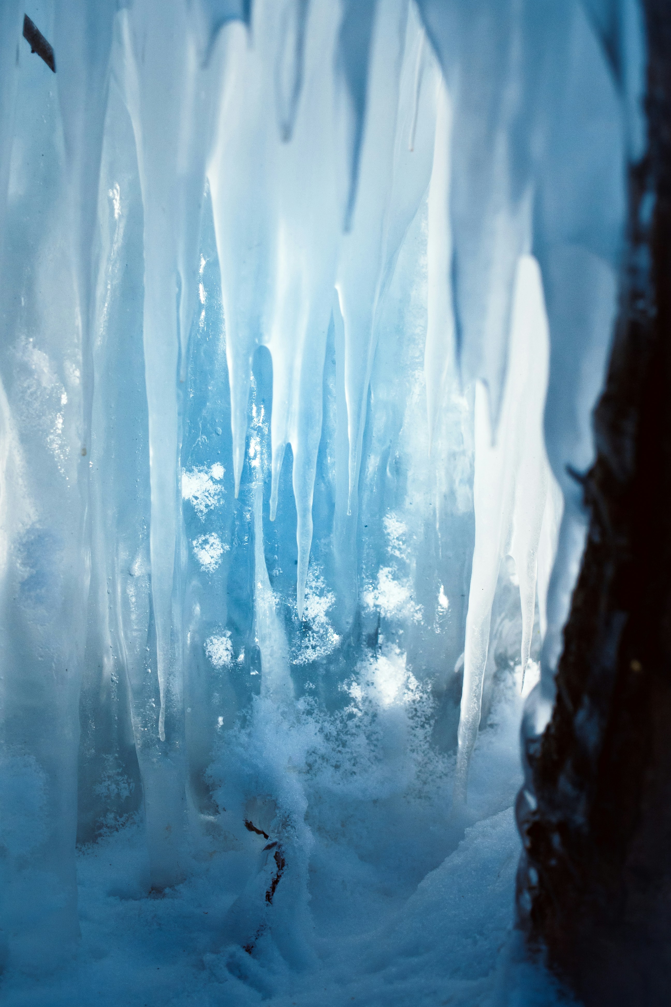 Translucent ice formations create a mesmerizing scene, revealing hints of light and texture within the frozen landscape.