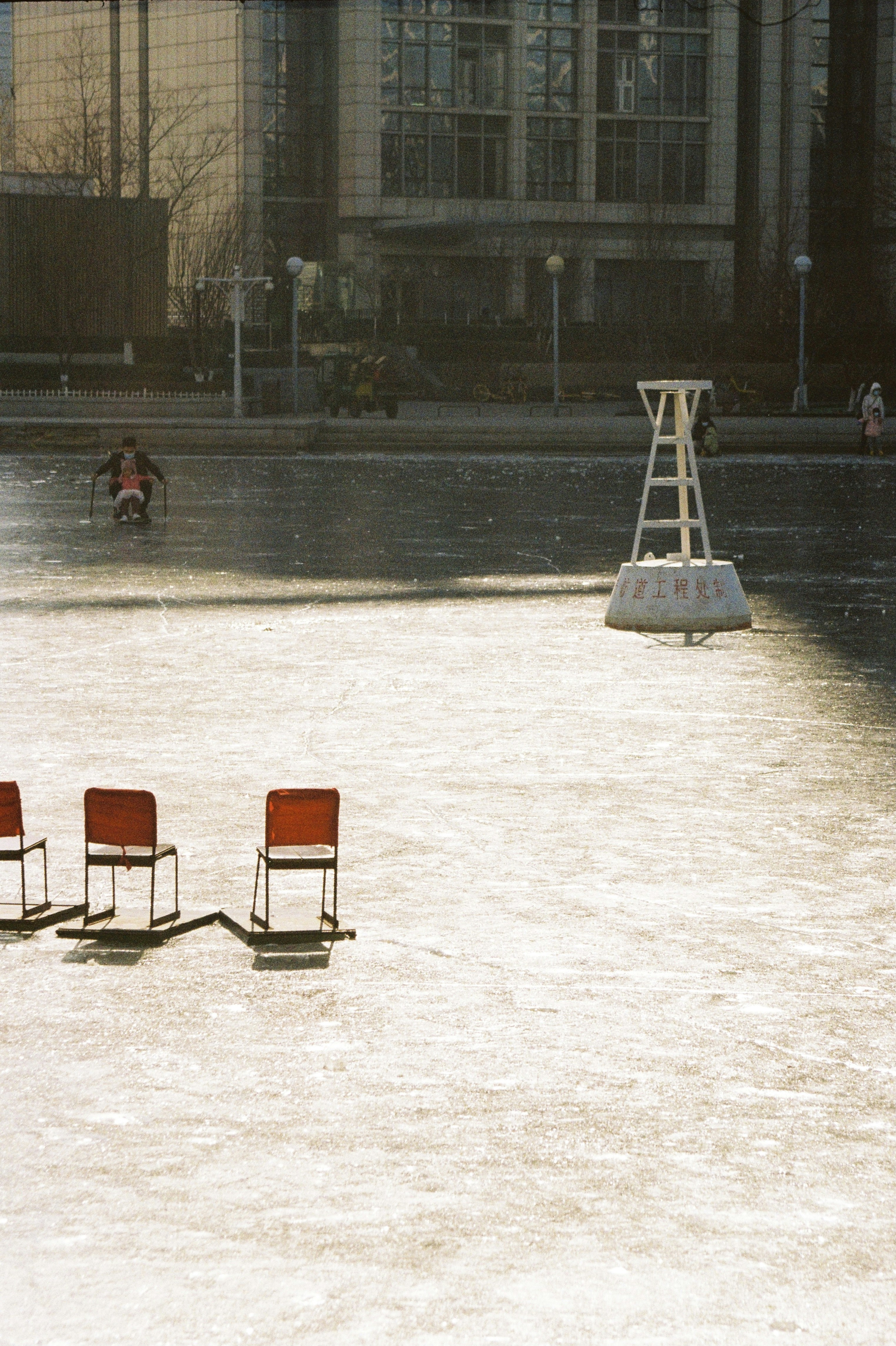 Sunlit Sentinel: Lifeguard Tower Anchors a Quiet Frozen Pond