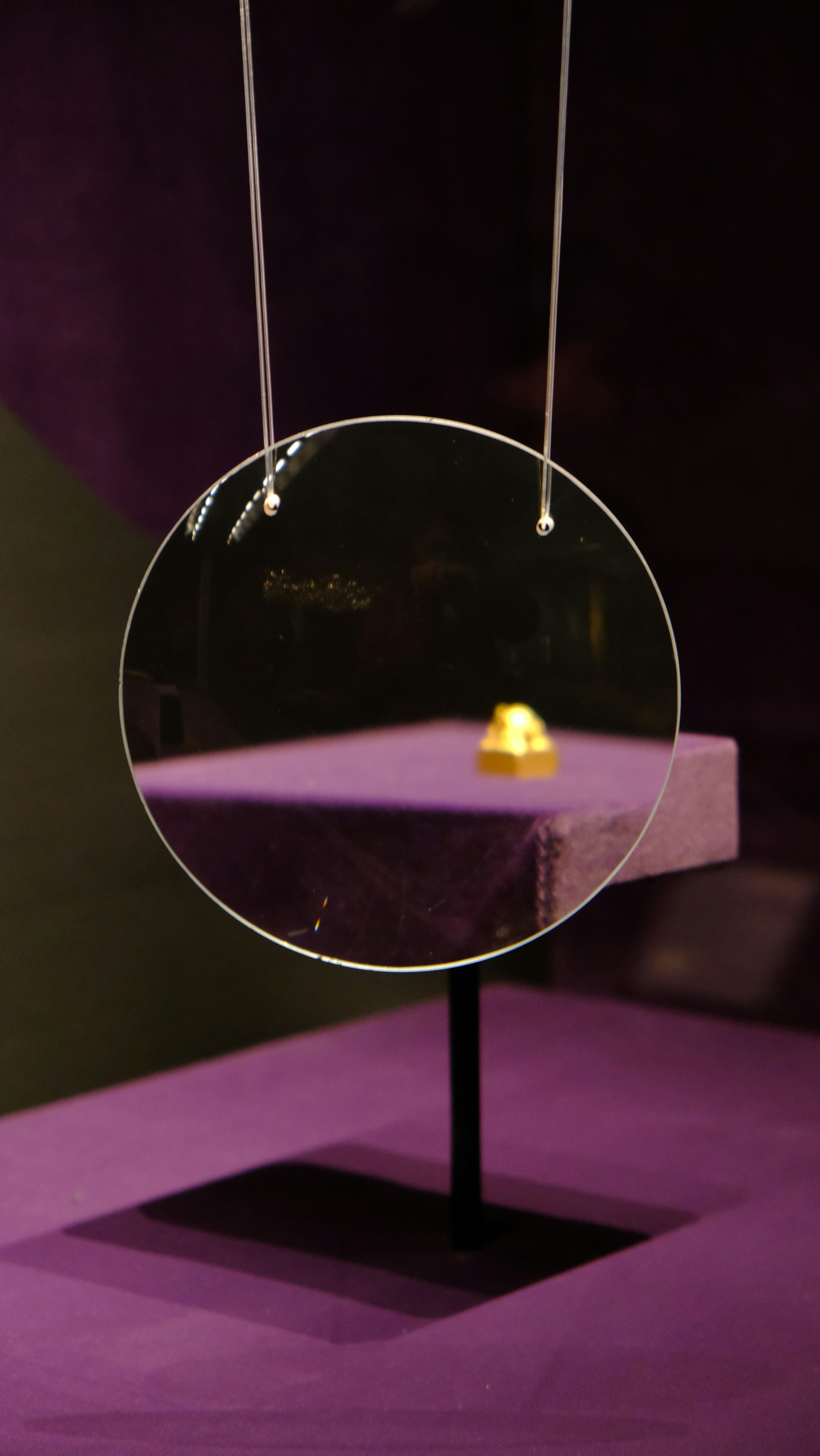 Tethered Circle Above Velvet Purple: A Quiet Stage Reflection