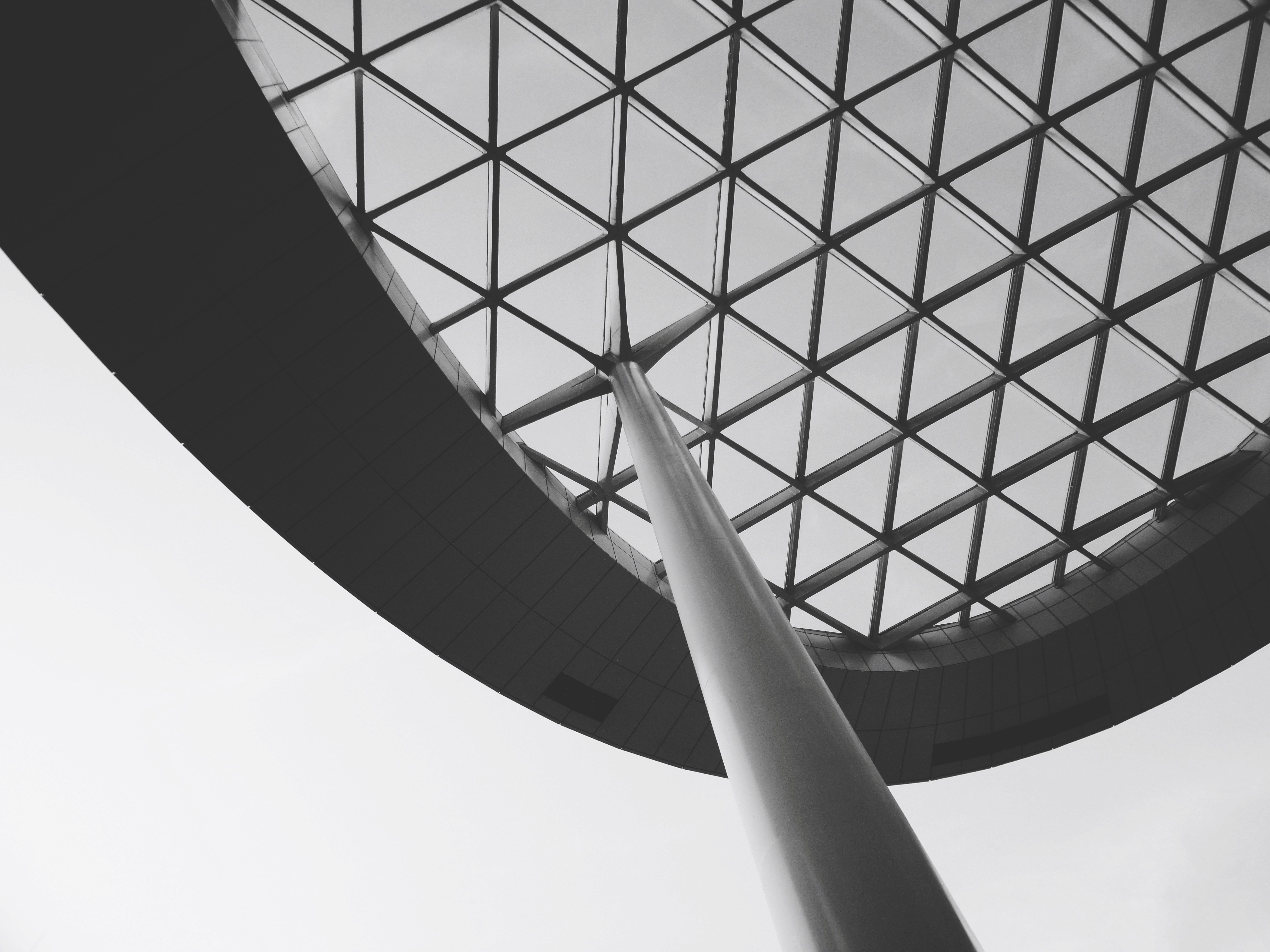 Under the Diamond Dome: A Central Mast Piercing the Circular Glass Canopy