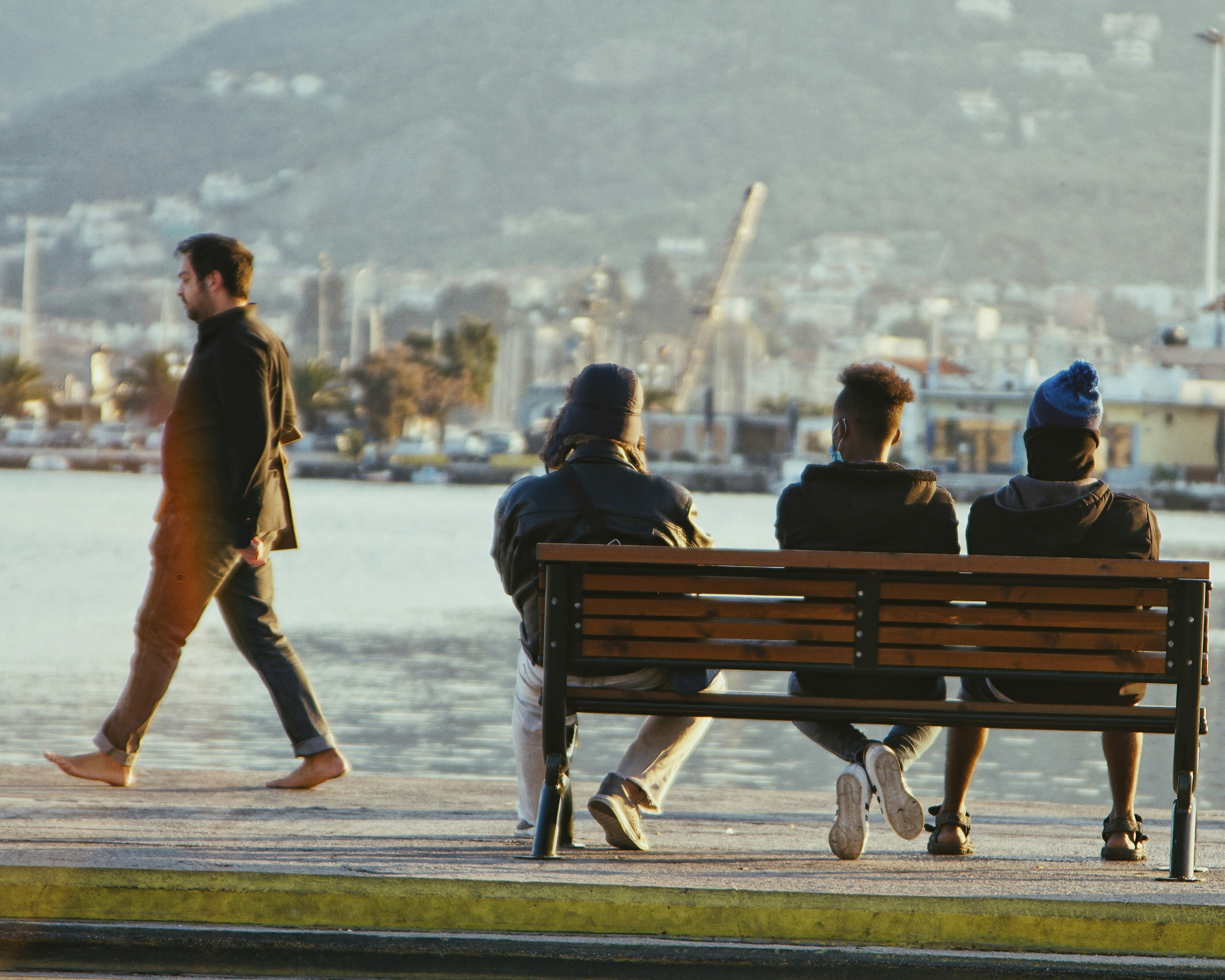 3 men sitting on bench during daytime photo – Free Bench Image on Unsplash