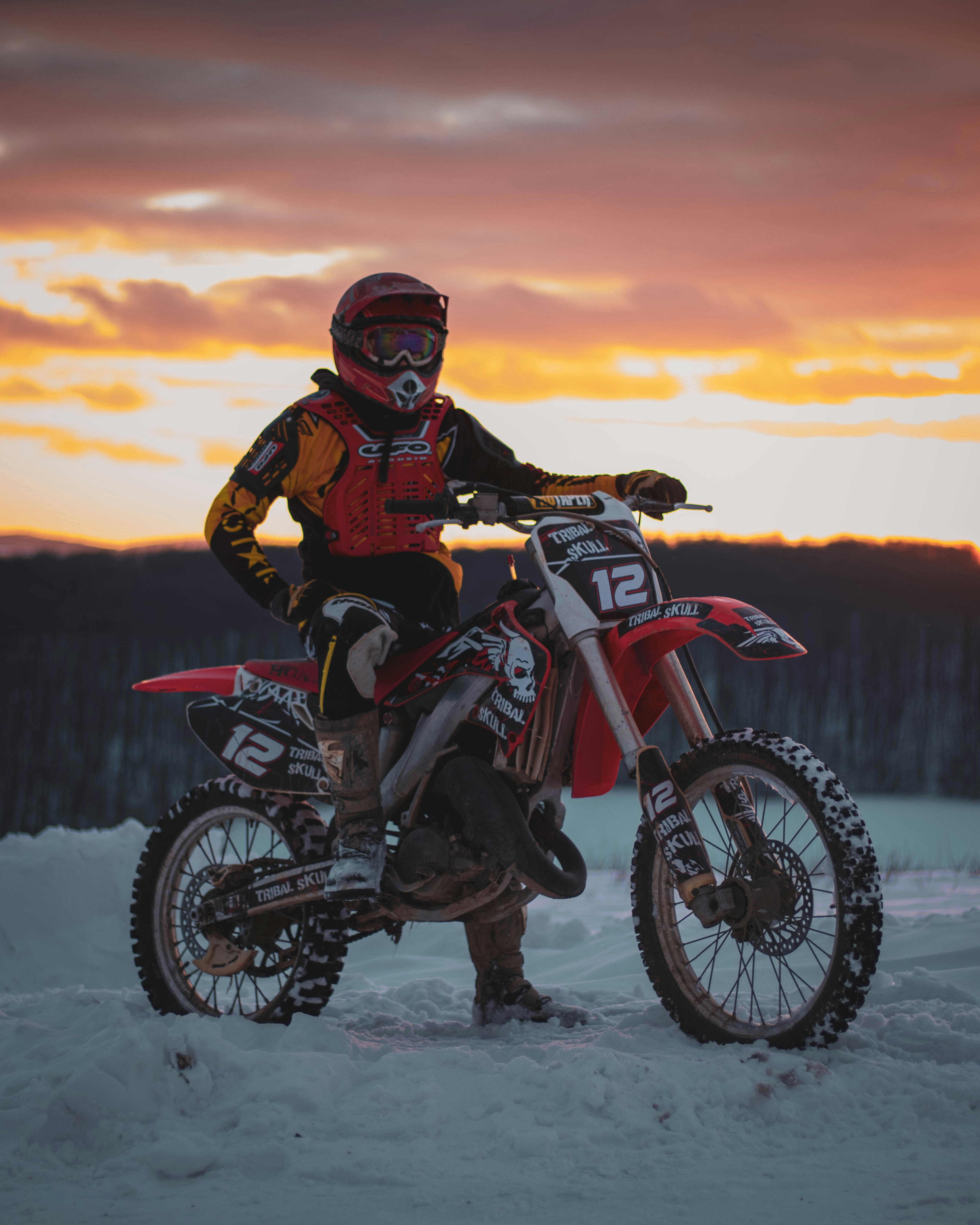 Ember Horizon: Snowbike Rider Silhouetted Against a Fiery Sunset