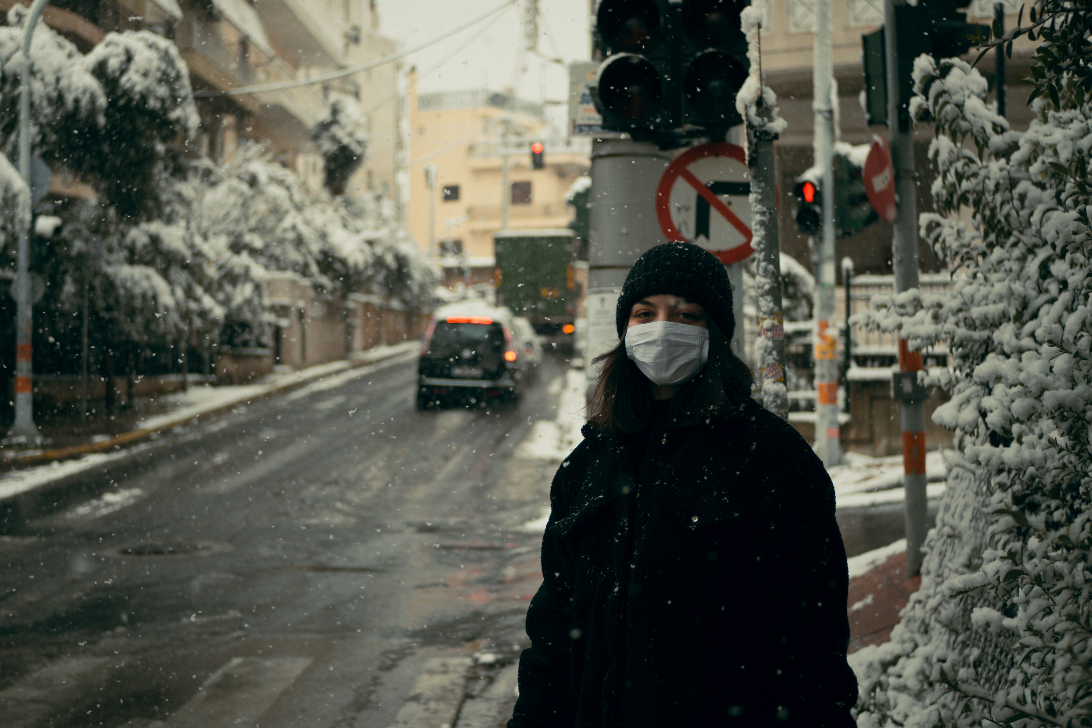 Masked Figure at a Snowbound Intersection