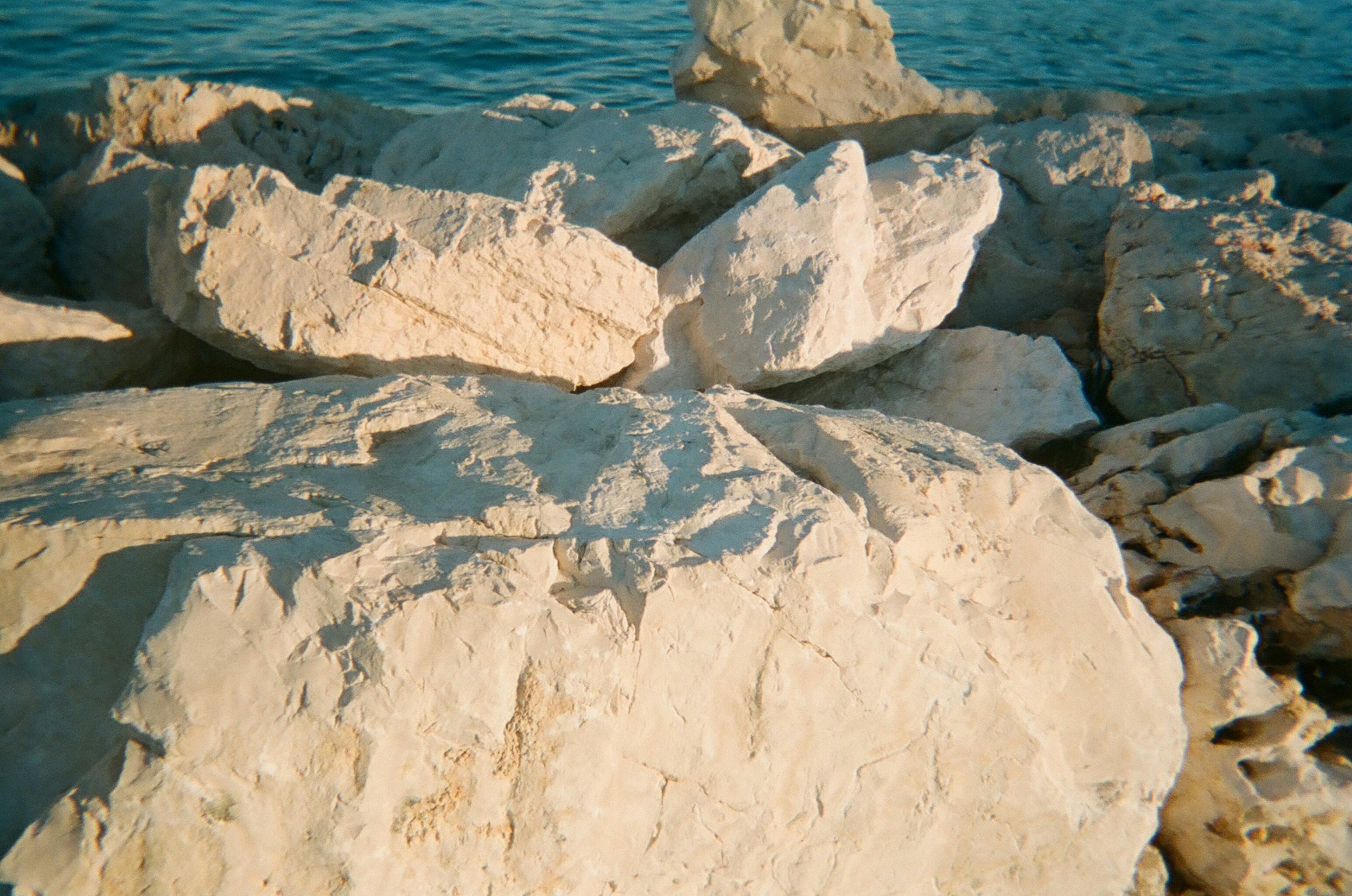 White rock formation near body of water during daytime photo – Free ...