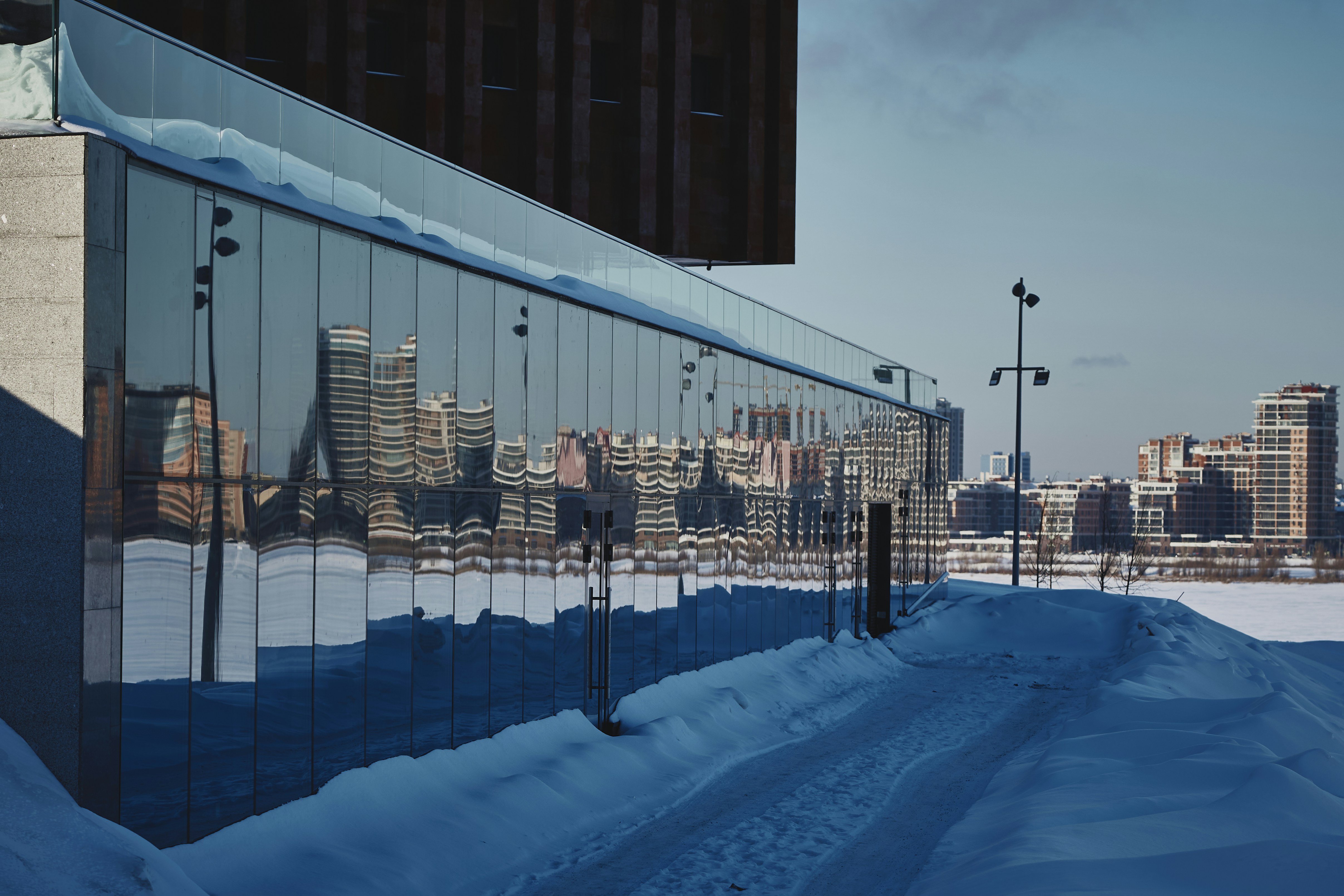 Glass Facade Echoes a Snowbound Skyline