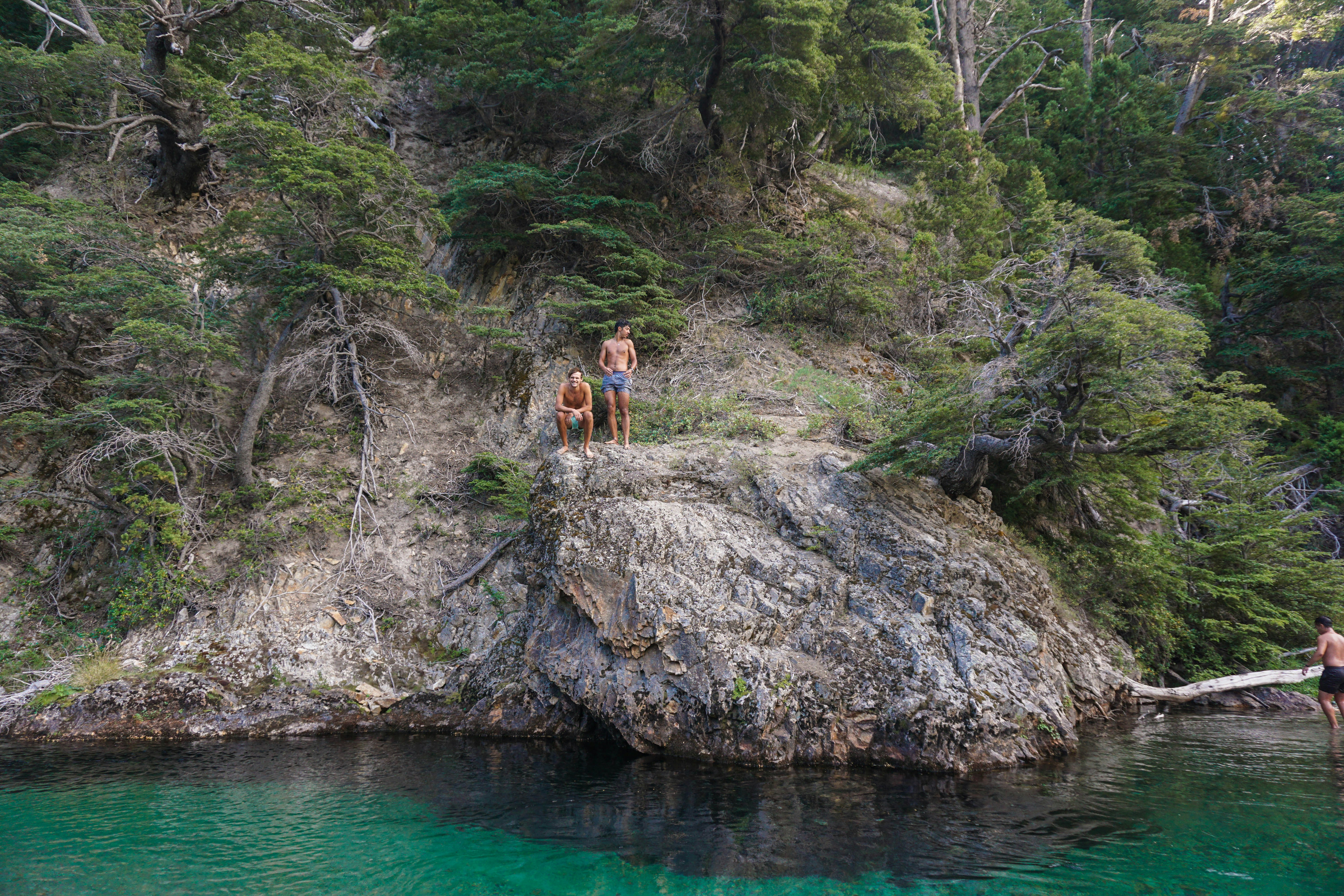 Three on a Rocky Ledge Over Turquoise Water