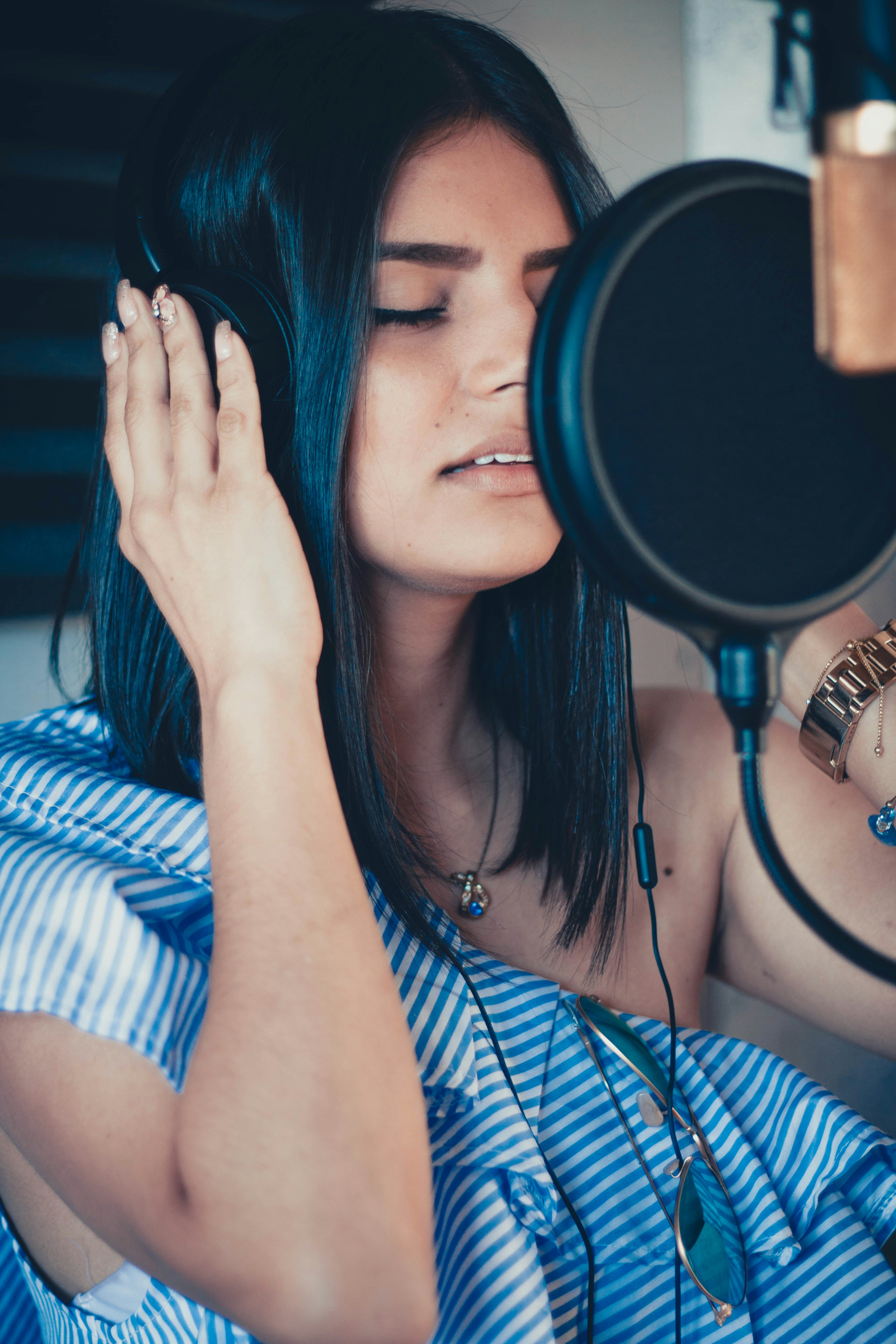 Blue-Toned Studio Take: Quiet Focus Behind the Microphone