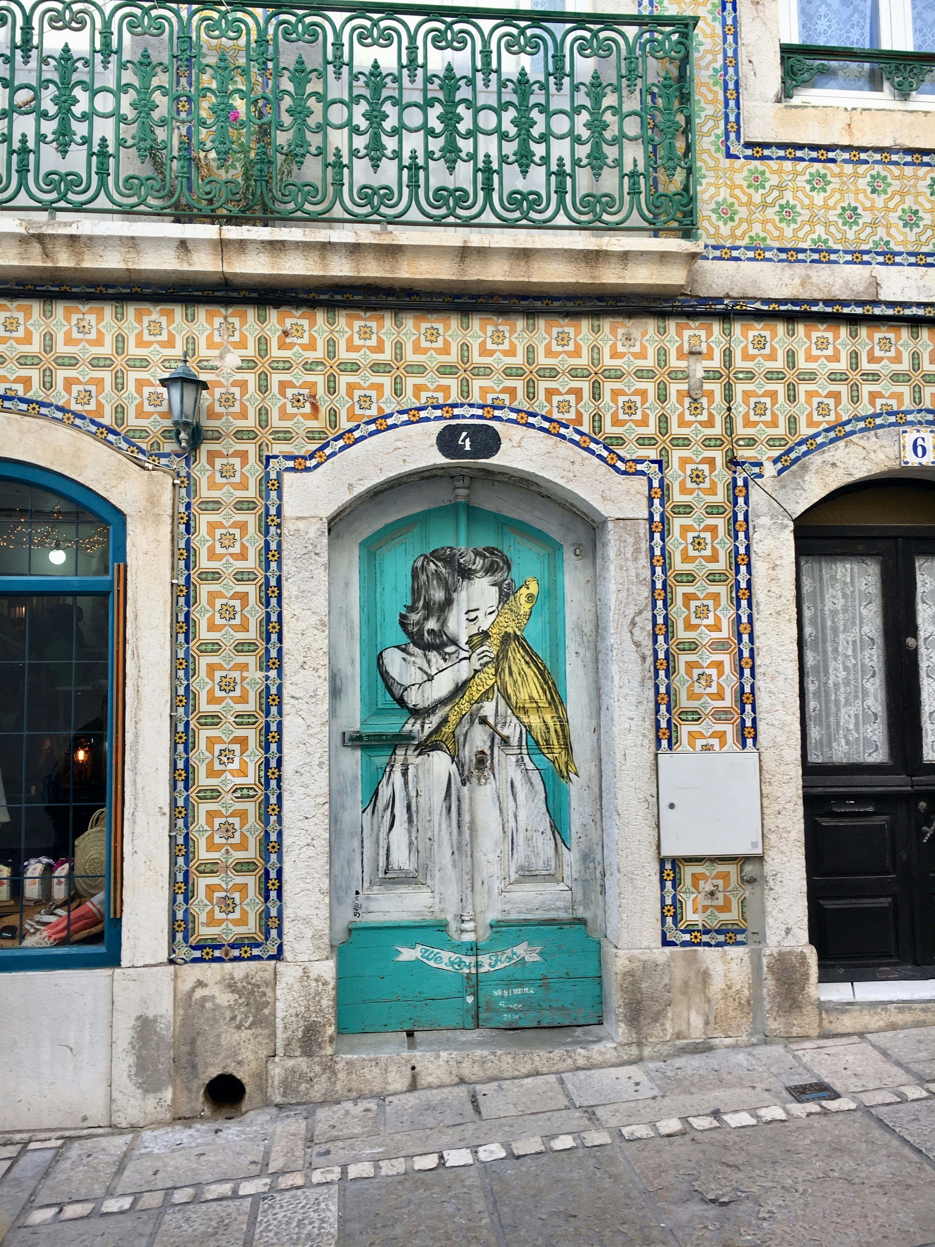 Turquoise Door Mural Beneath Lisbon's Azulejo Veil