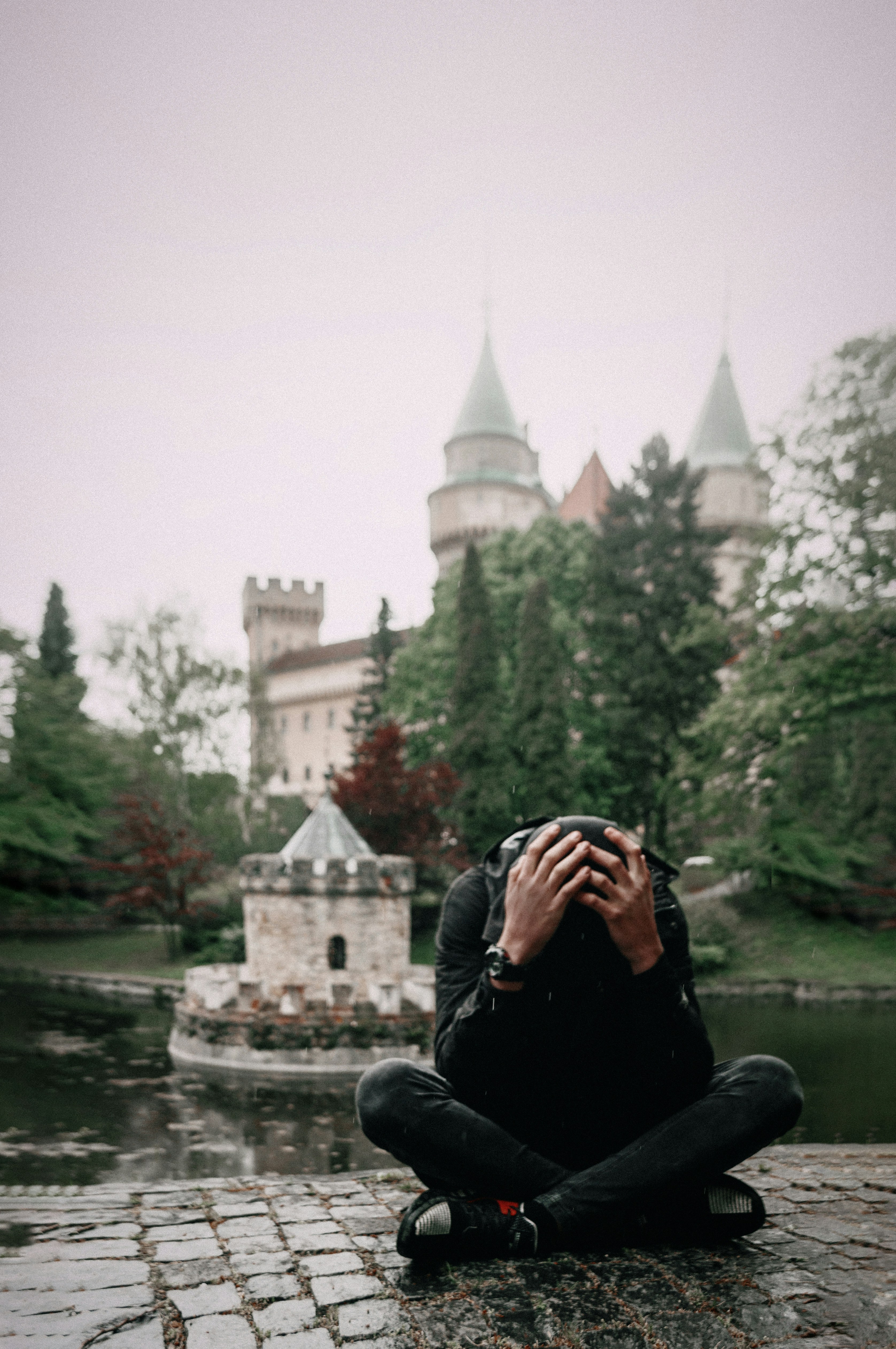 Head in Hands: A Quiet Moment by the Castle Courtyard