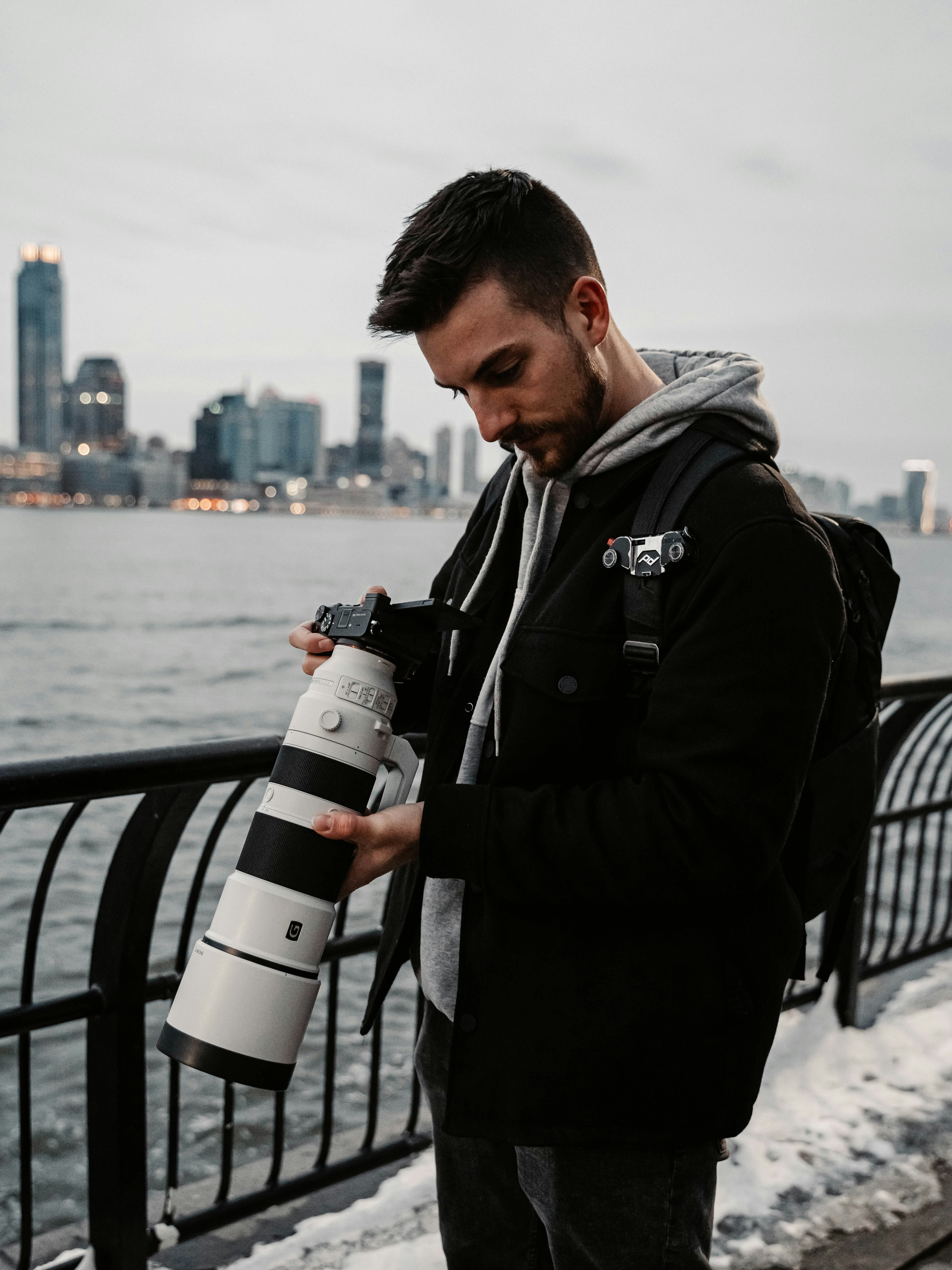 Portrait by the Waterfront: Photographer with a Telephoto Grip